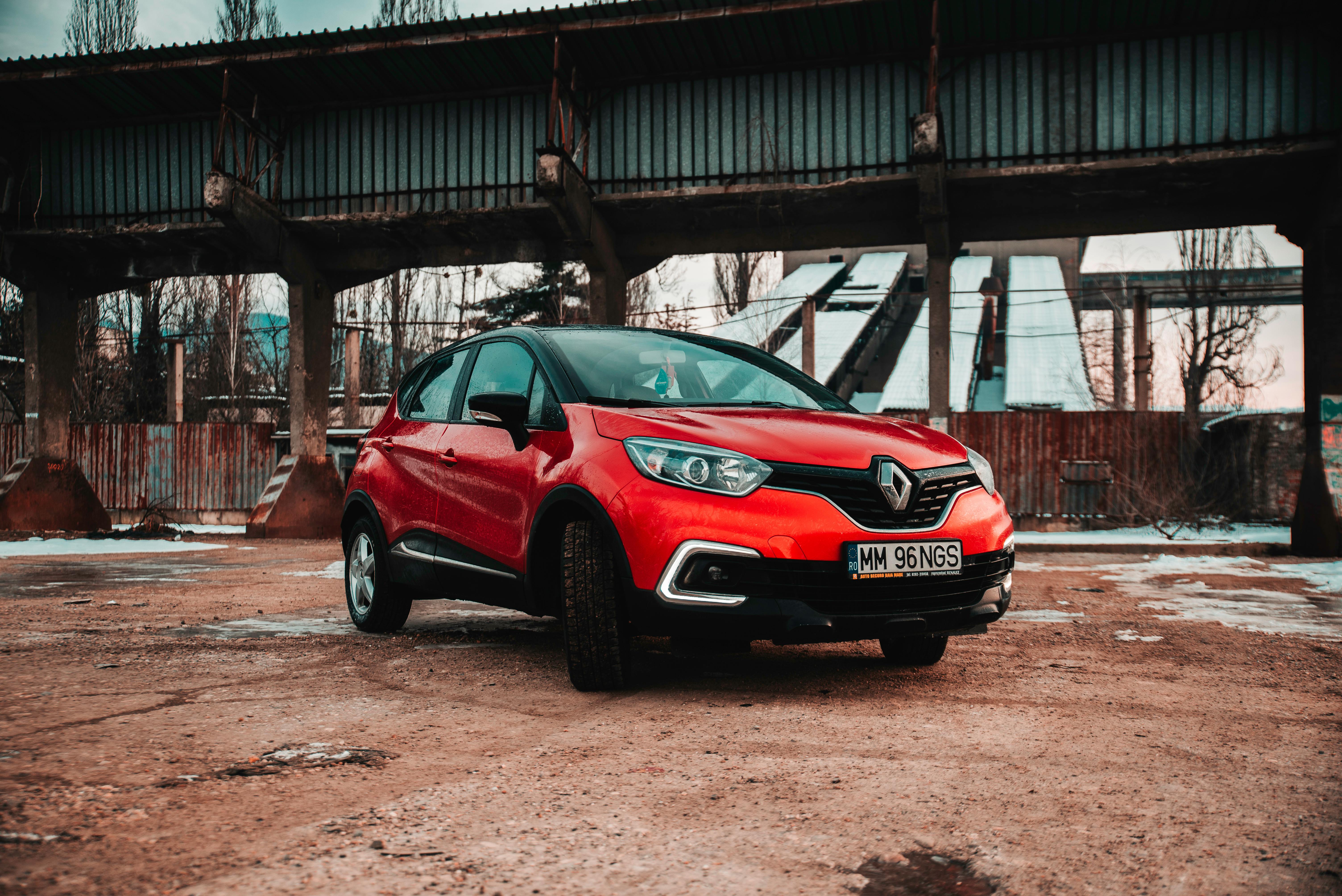 A Red Renault Captur Parked in an Industrial Area · Free Stock Photo