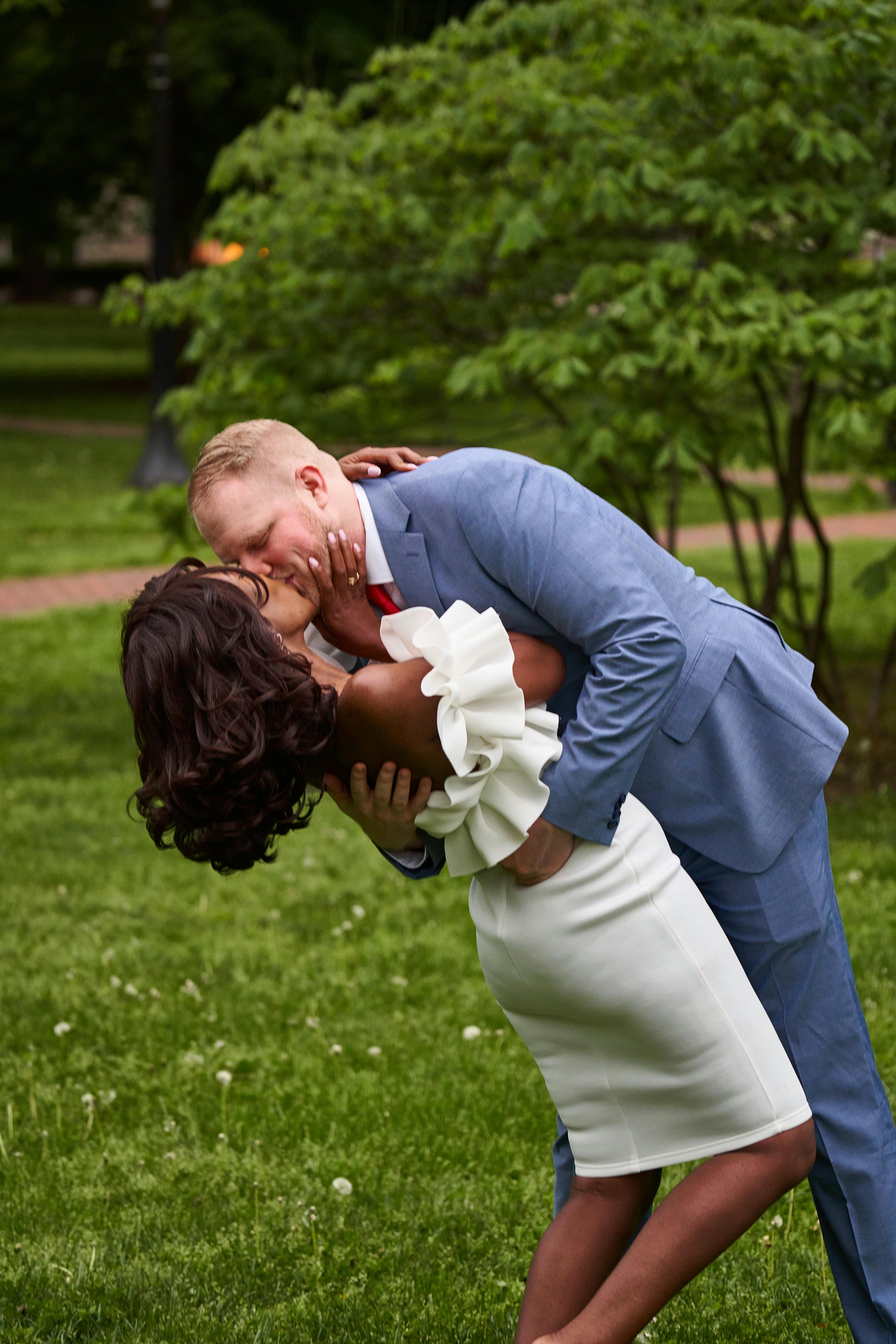 Man Wearing a Suit Kissing a Woman Wearing a White Dress with Ruffles ...