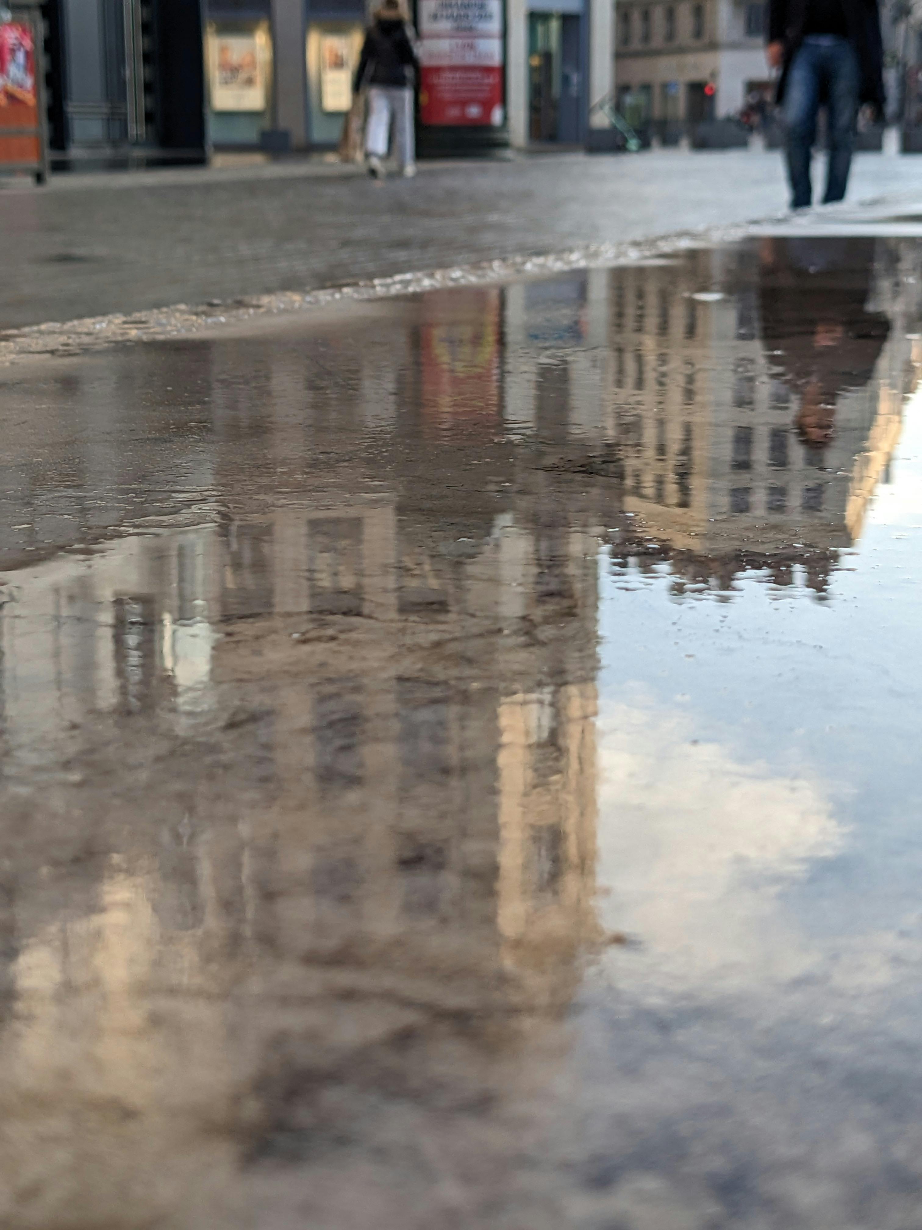 Buildings in City Reflecting in a Puddle on the Street · Free Stock Photo
