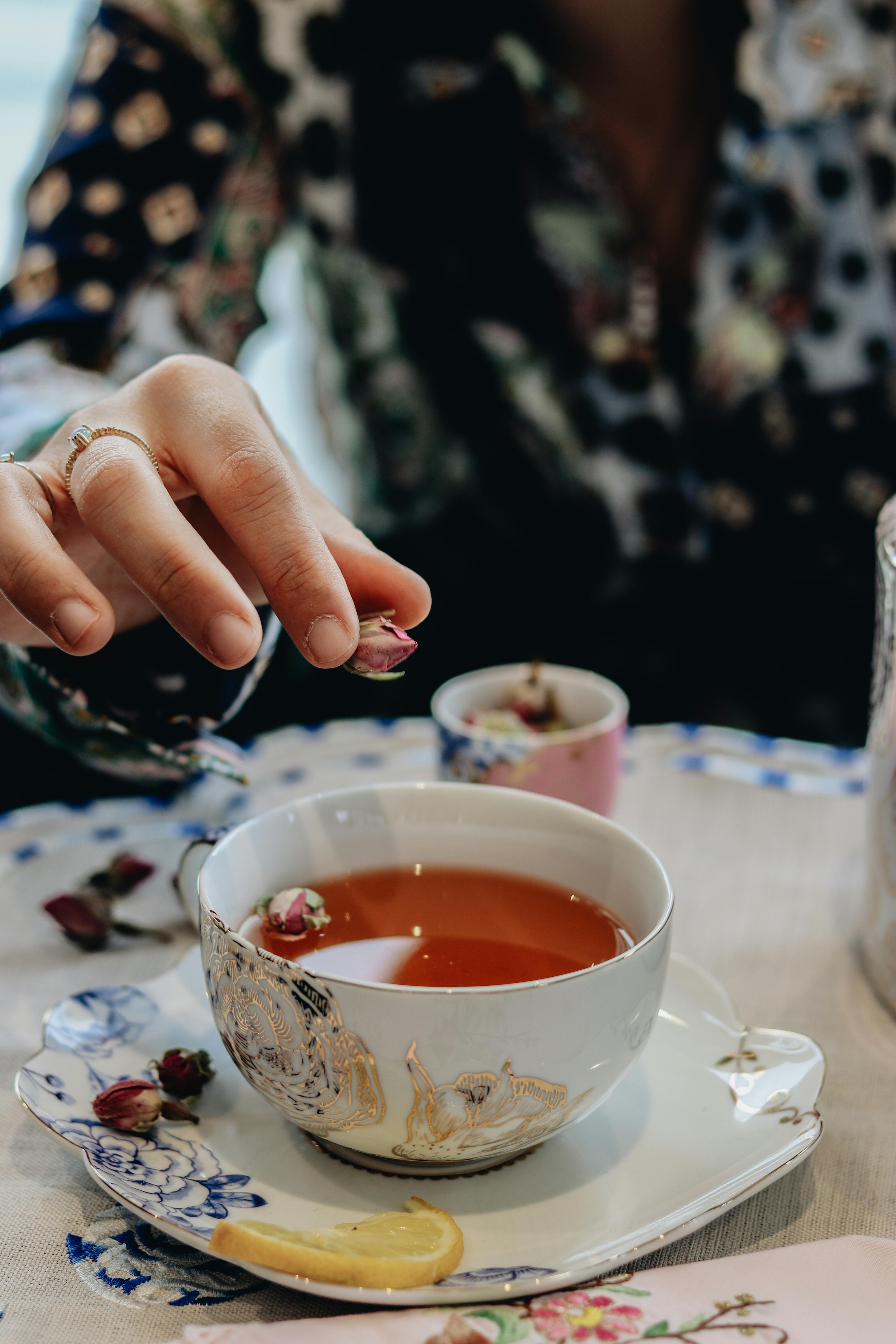 Person Holding Cup Filled With Brown Liquid · Free Stock Photo