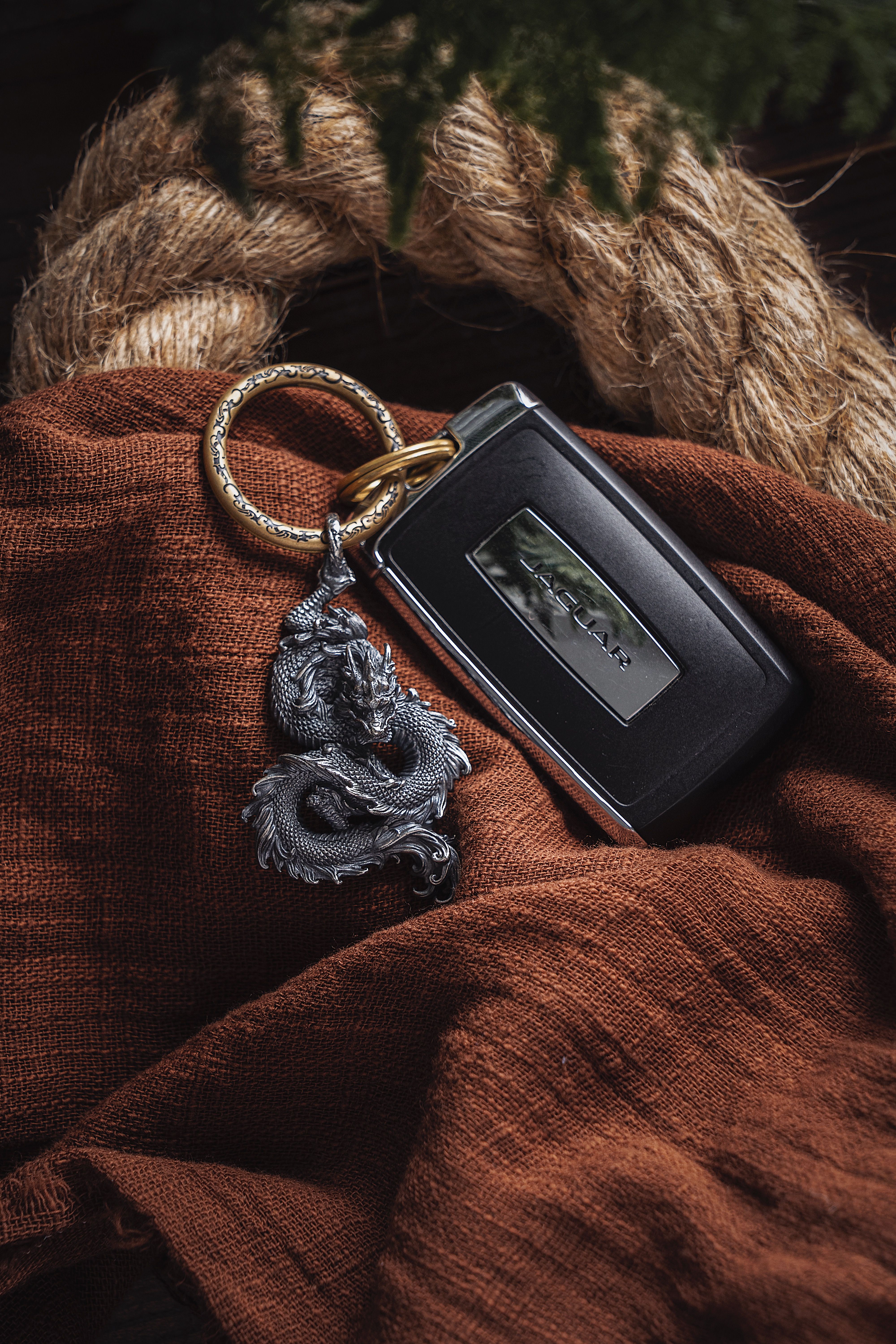 Dragon Keychain and Car Keys on Fabric · Free Stock Photo