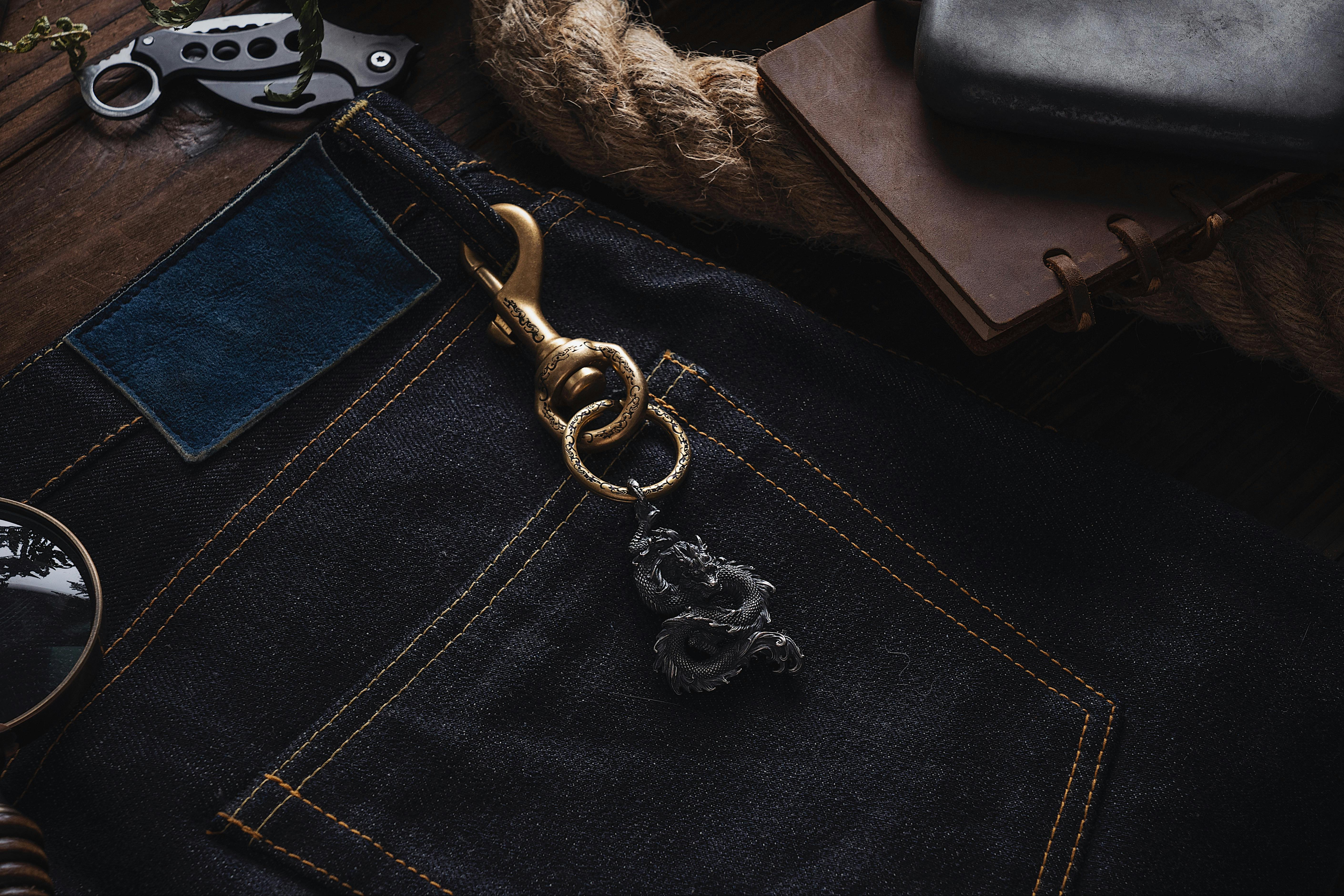 Chinese Dragon Keychain on a Pair of Jeans · Free Stock Photo