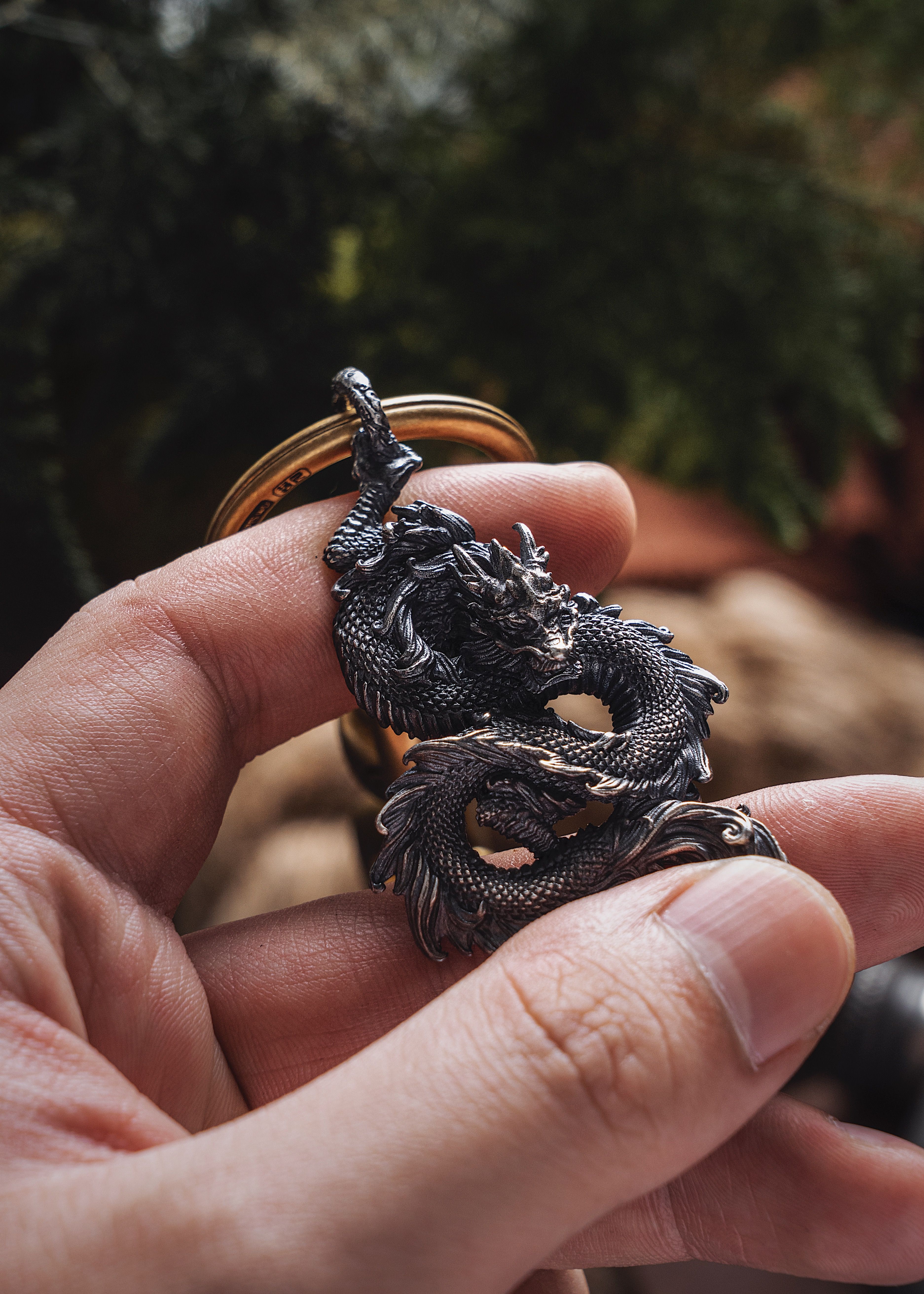 Close Up of Dragon Pendant on Hand · Free Stock Photo