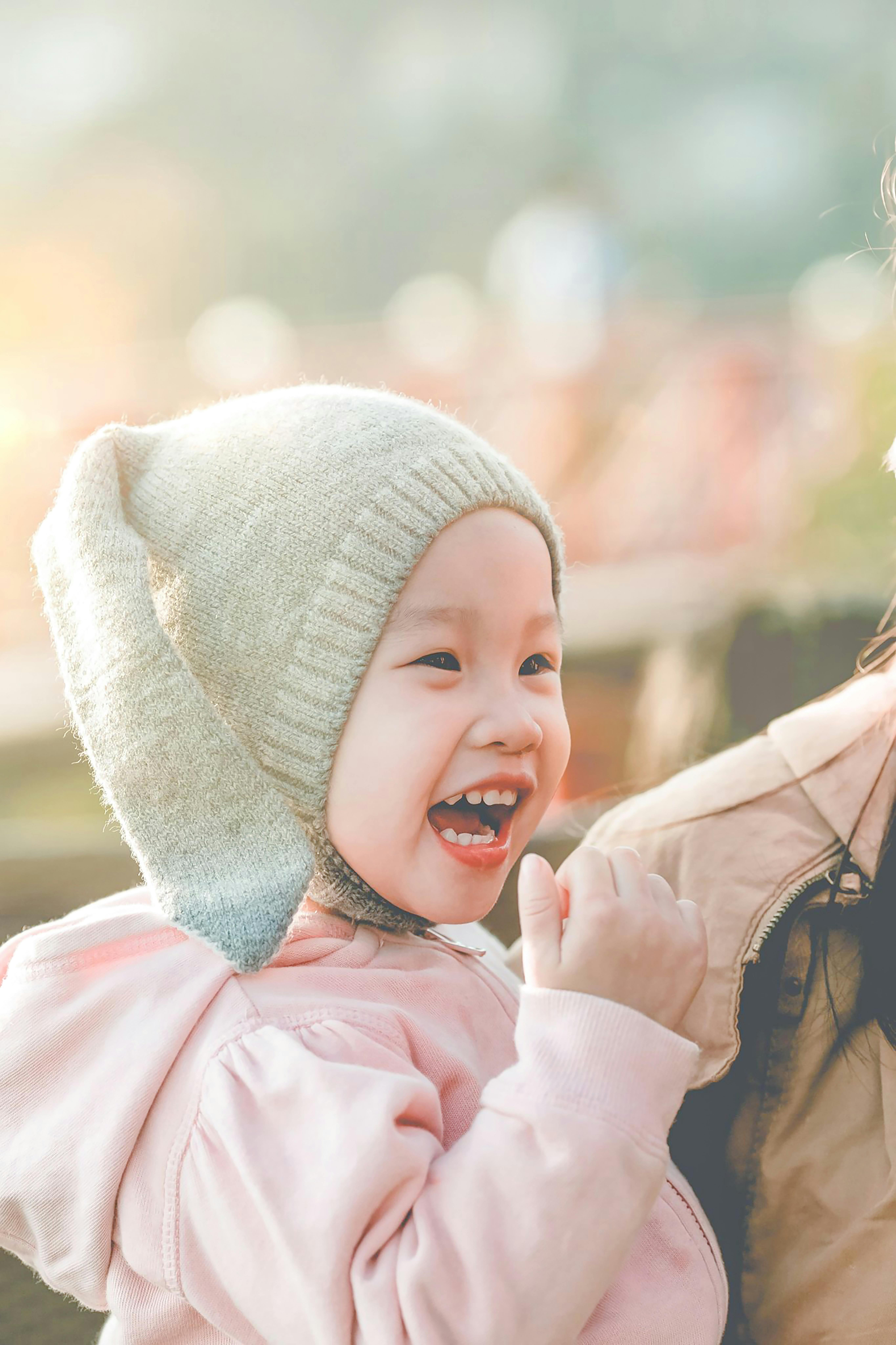 Person Holding Laughing Baby Girl · Free Stock Photo