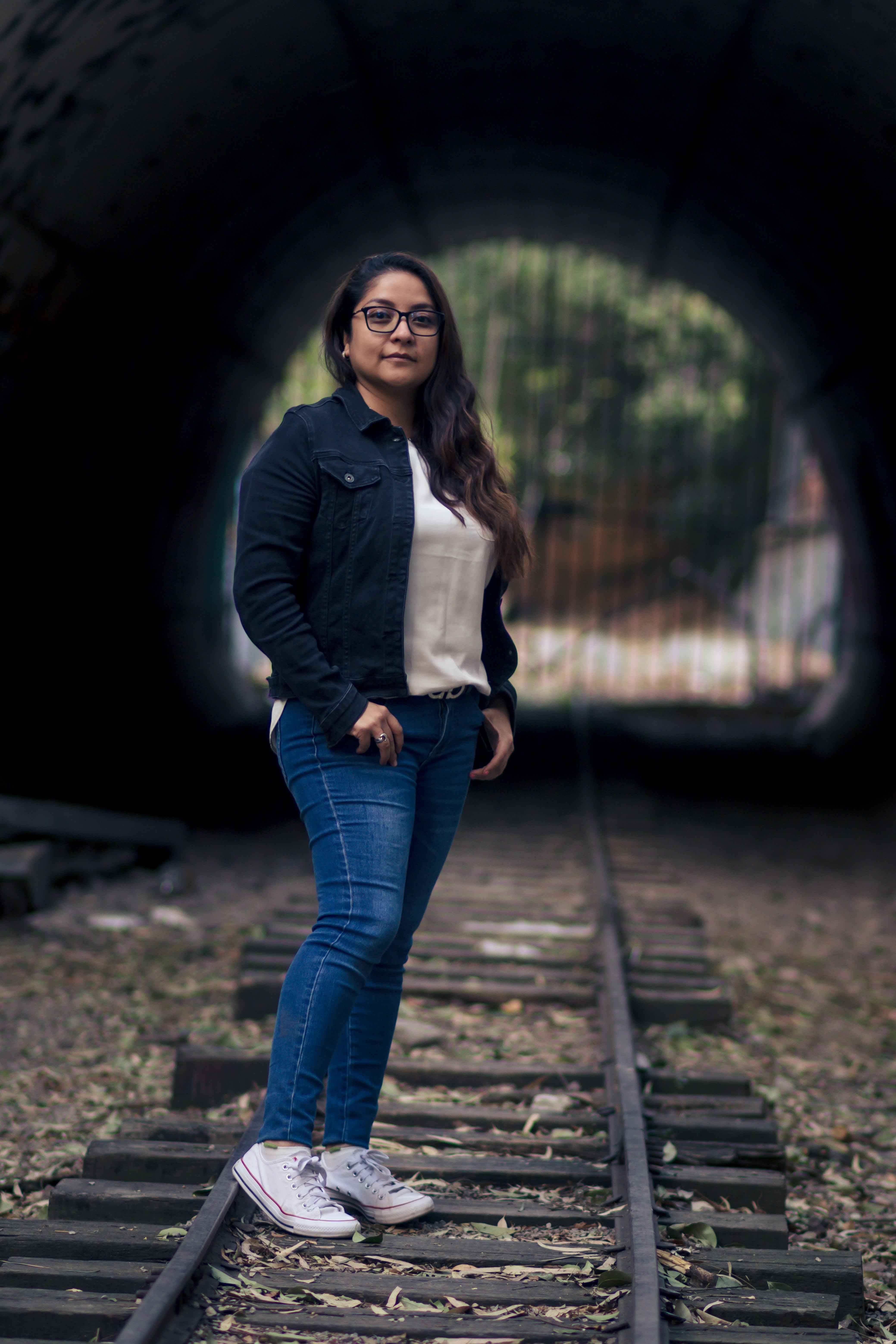 Casual Style Woman on Railway Tracks · Free Stock Photo