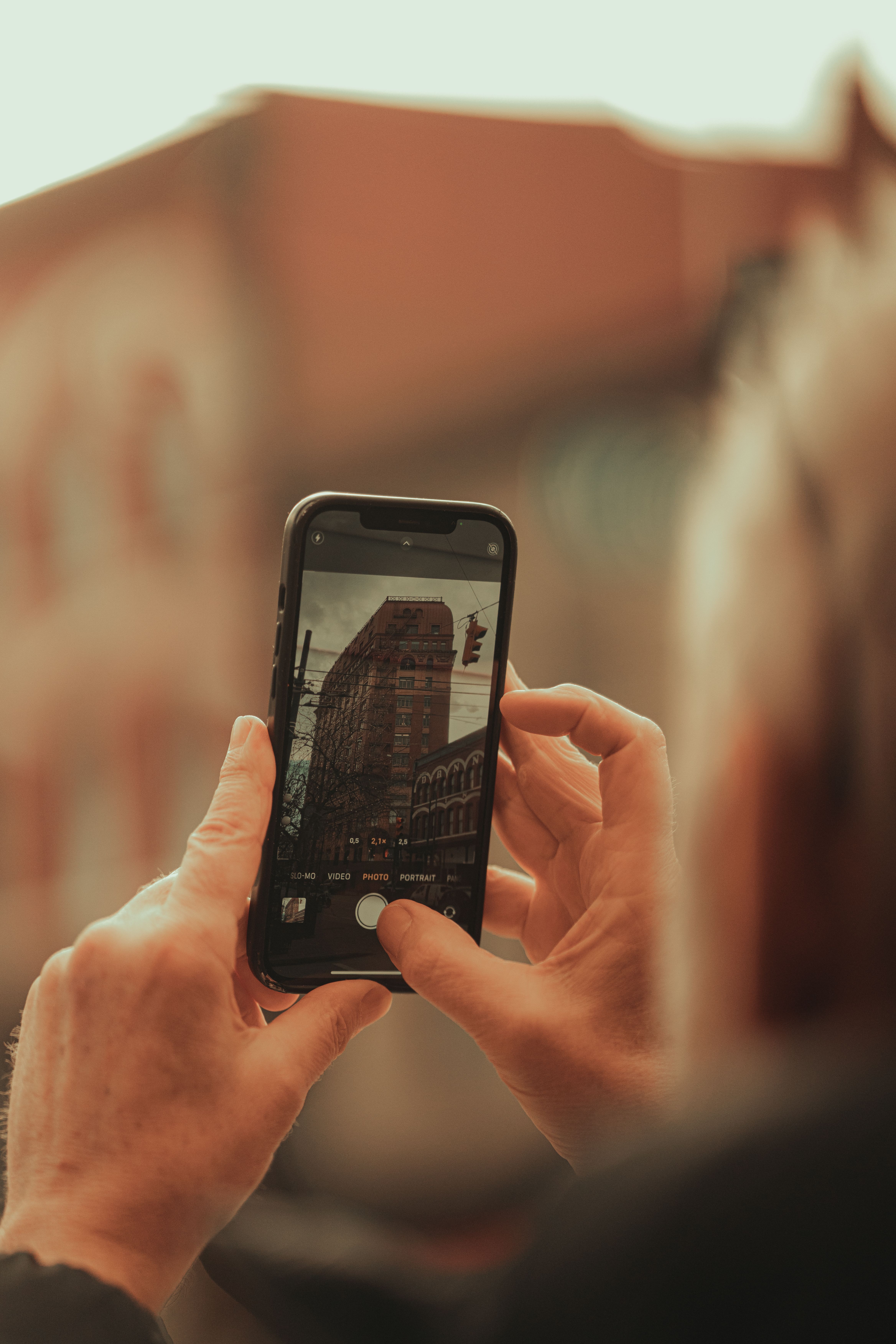Man Photographing Building on City Street · Free Stock Photo