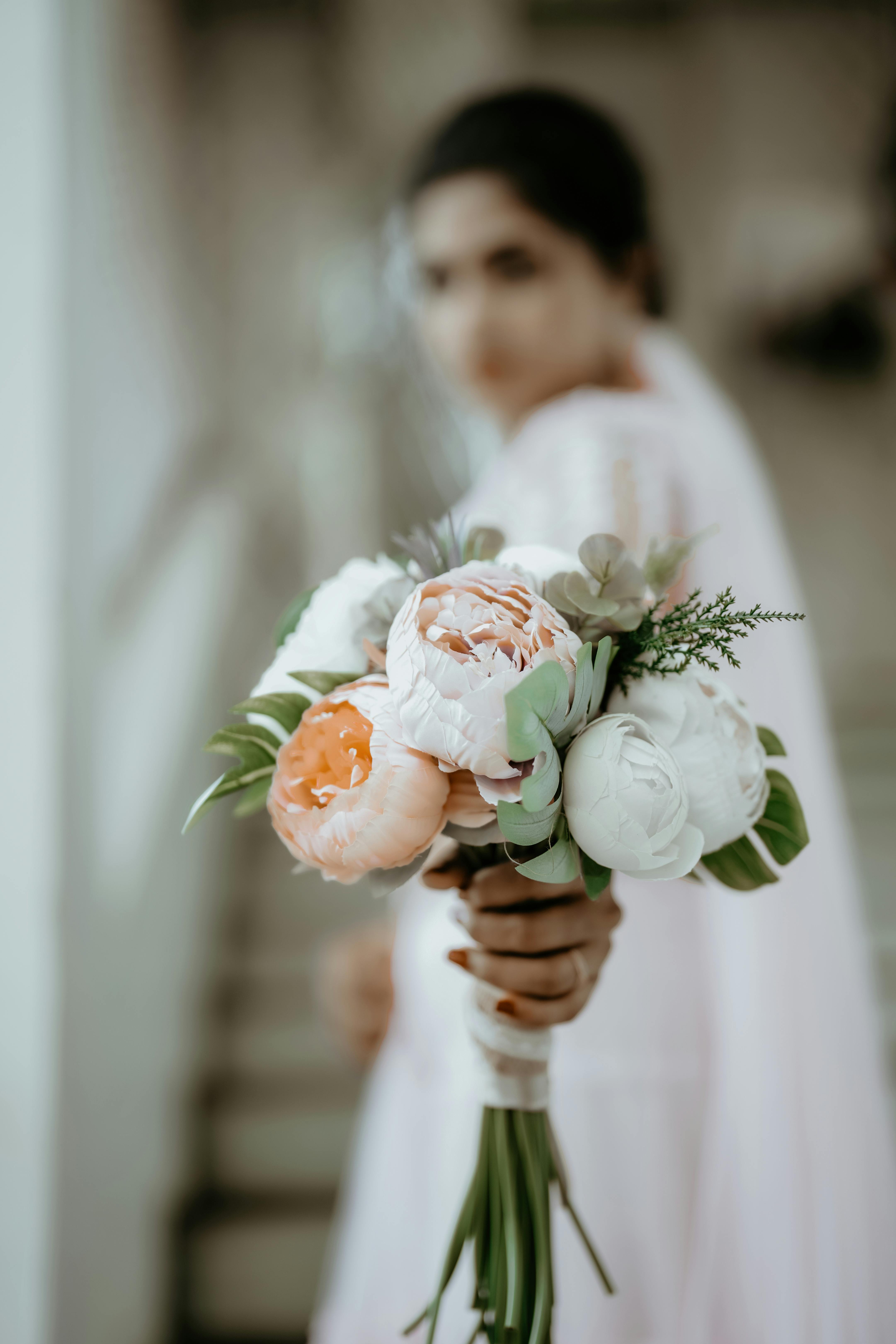 Close-up View of Bride Holding Flower Bouquet · Free Stock Photo