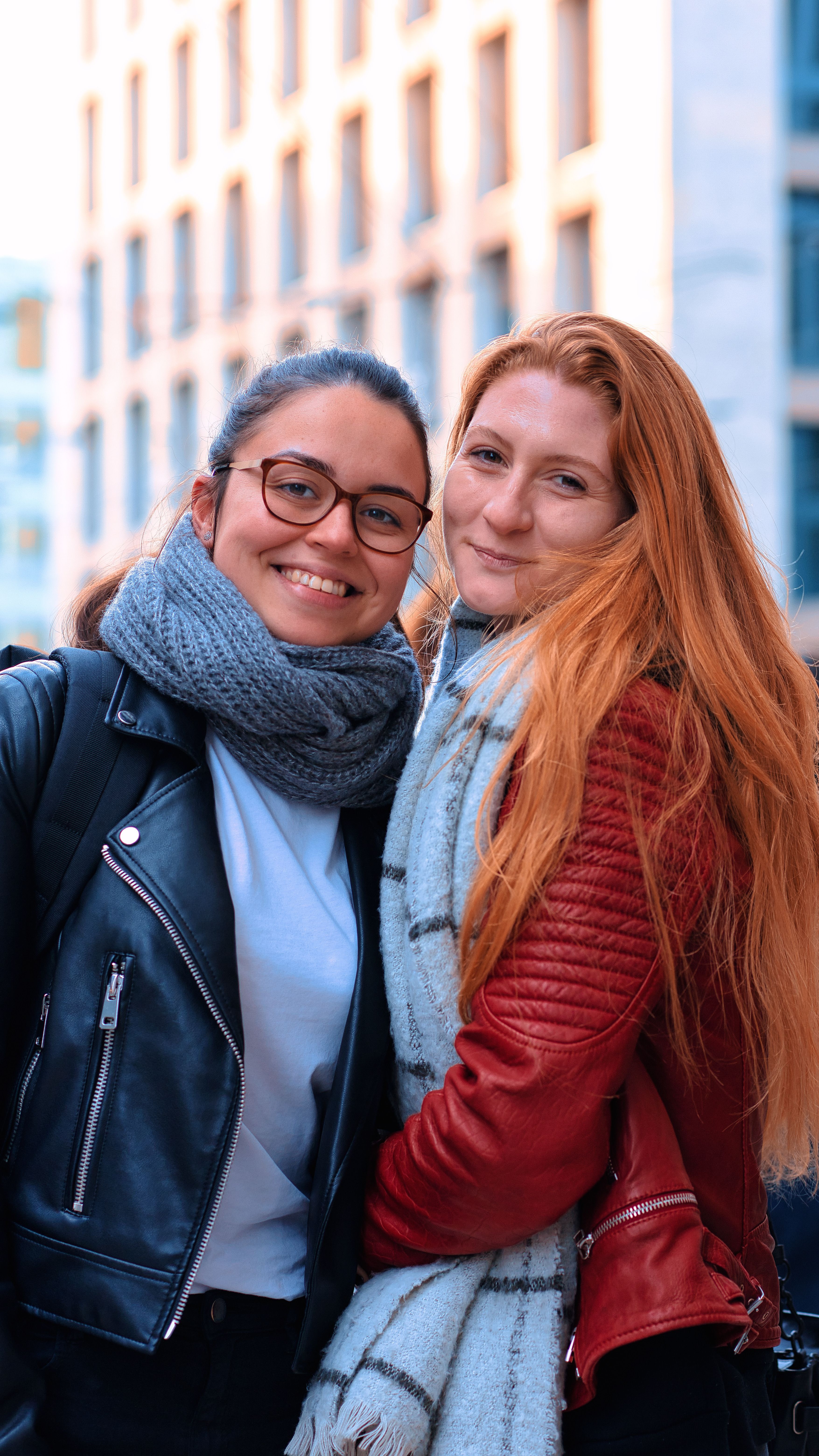 Two Women in Jackets Standing in City and Smiling · Free Stock Photo