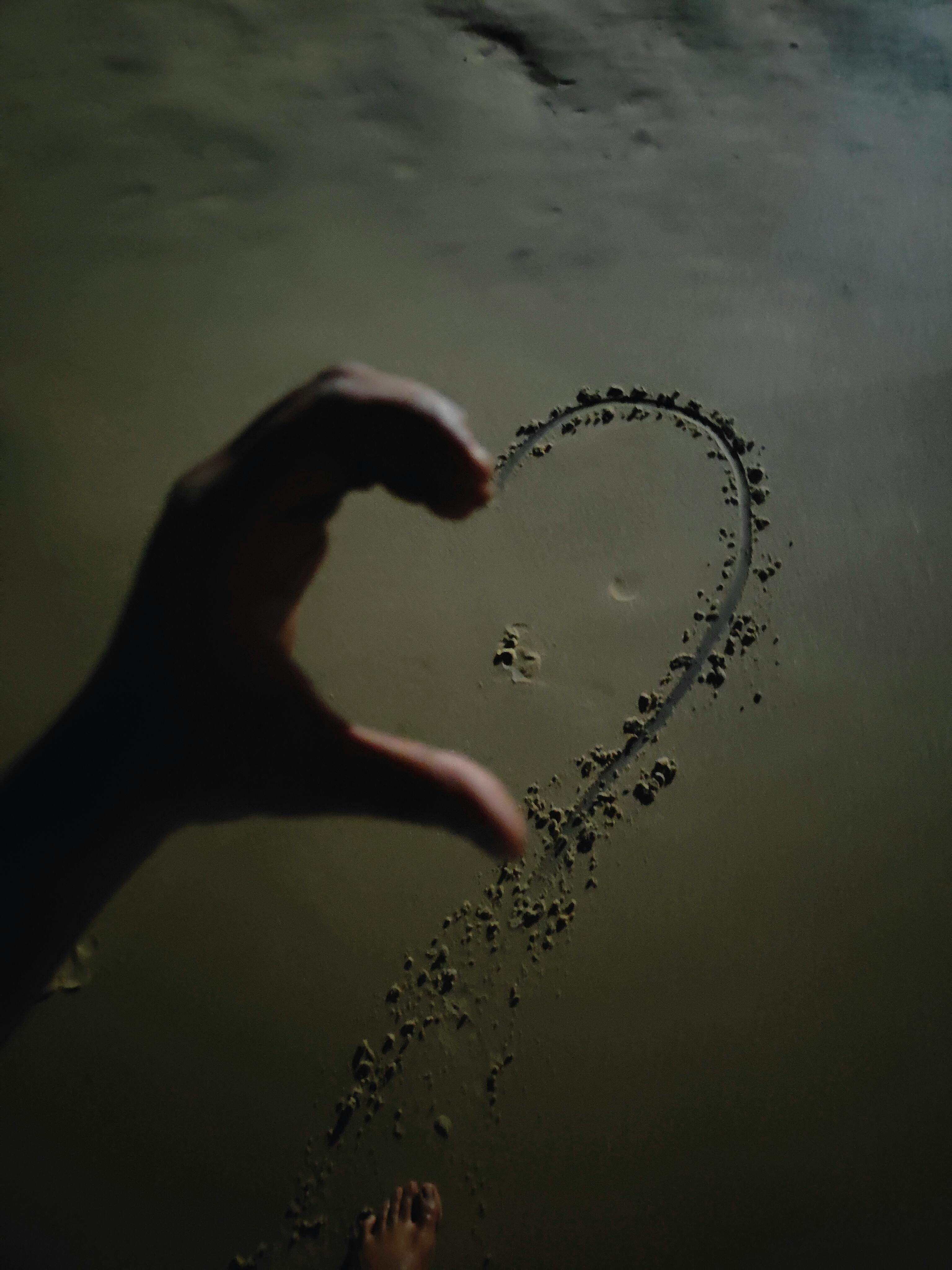 Hand over Heart on Sand · Free Stock Photo