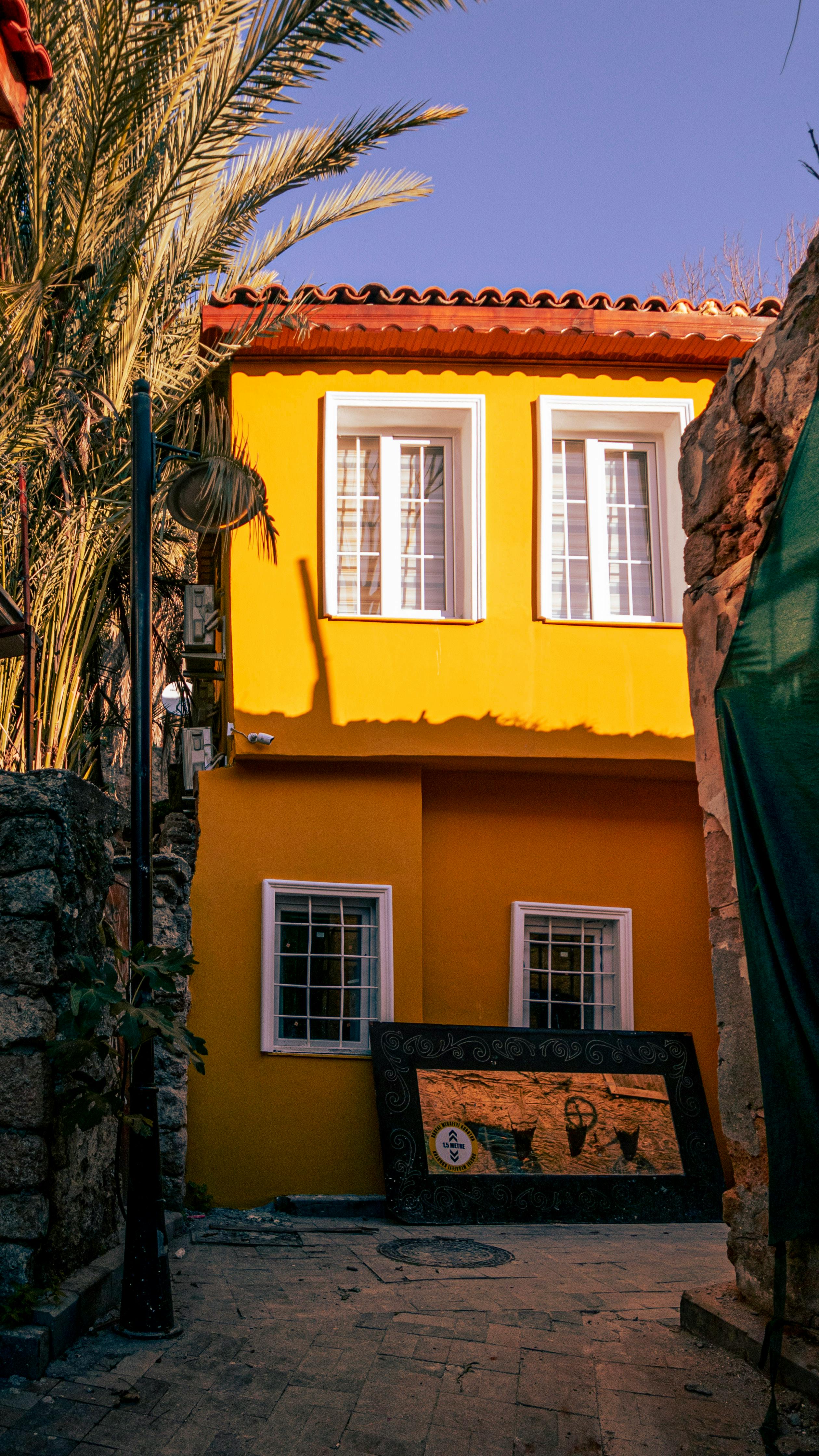 Concrete Road Between Wall And Houses · Free Stock Photo