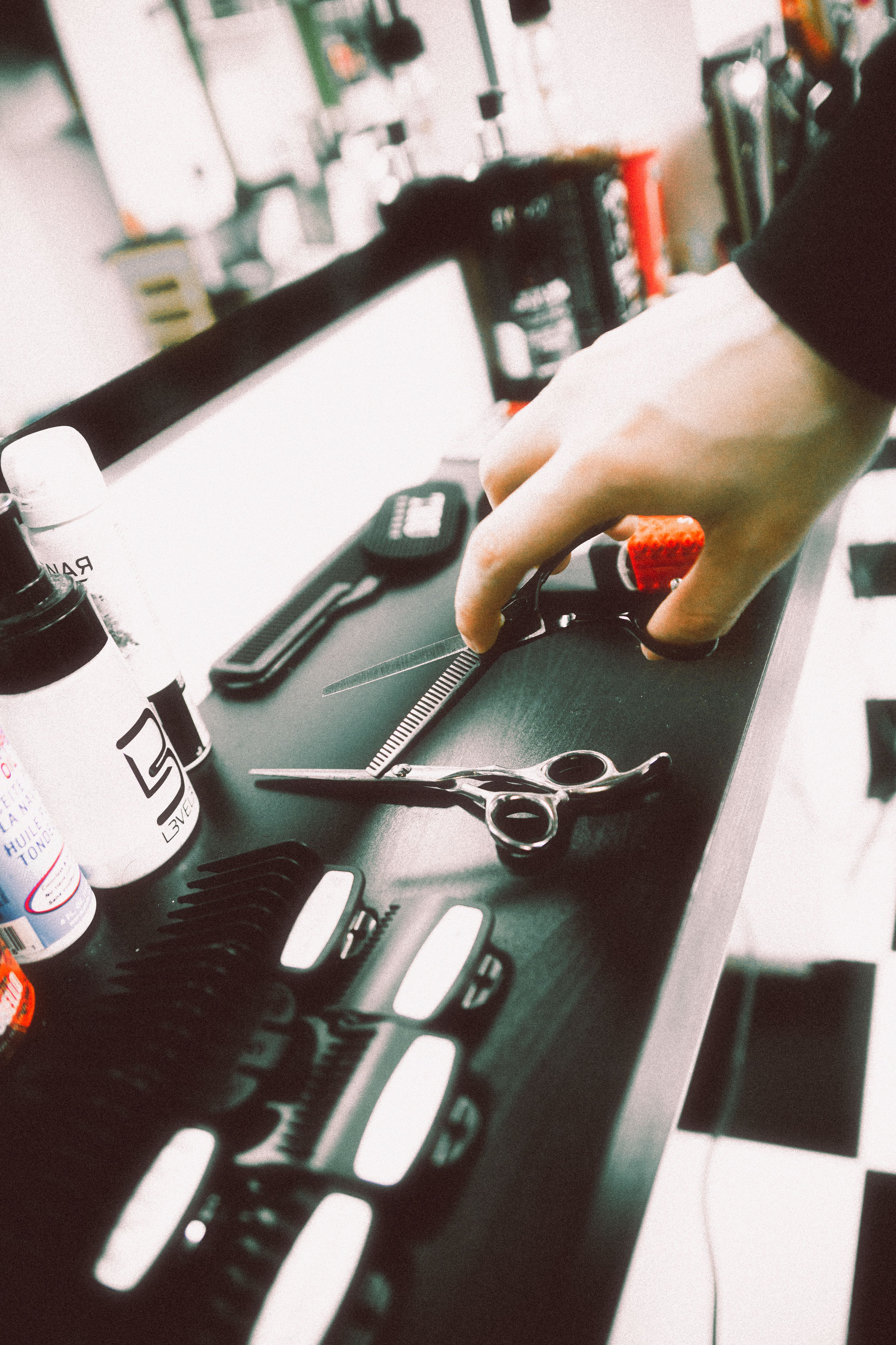 Hand over Scissors on Table in Barber Shop · Free Stock Photo