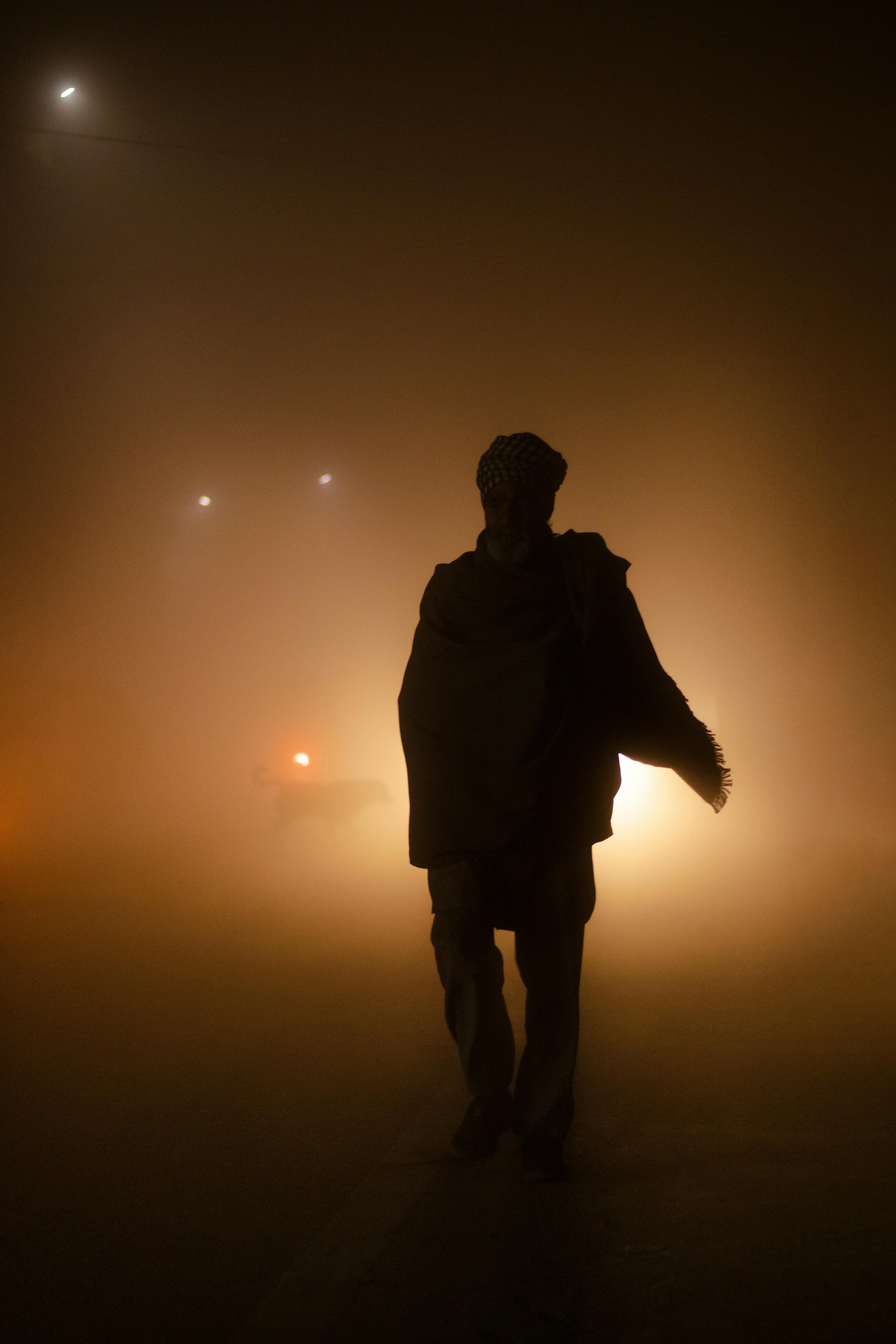 Silhouette of a Man Walking on a Street Back Lit by Car Lights · Free ...
