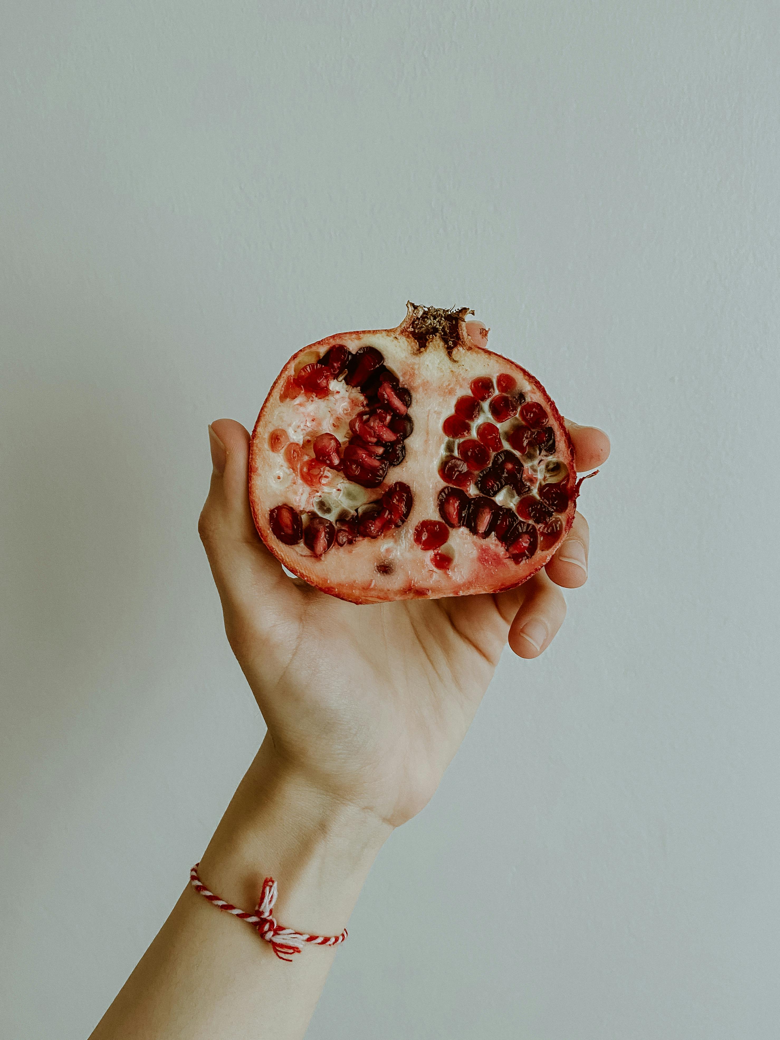 Red Pomegranate at Woman's Hand · Free Stock Photo