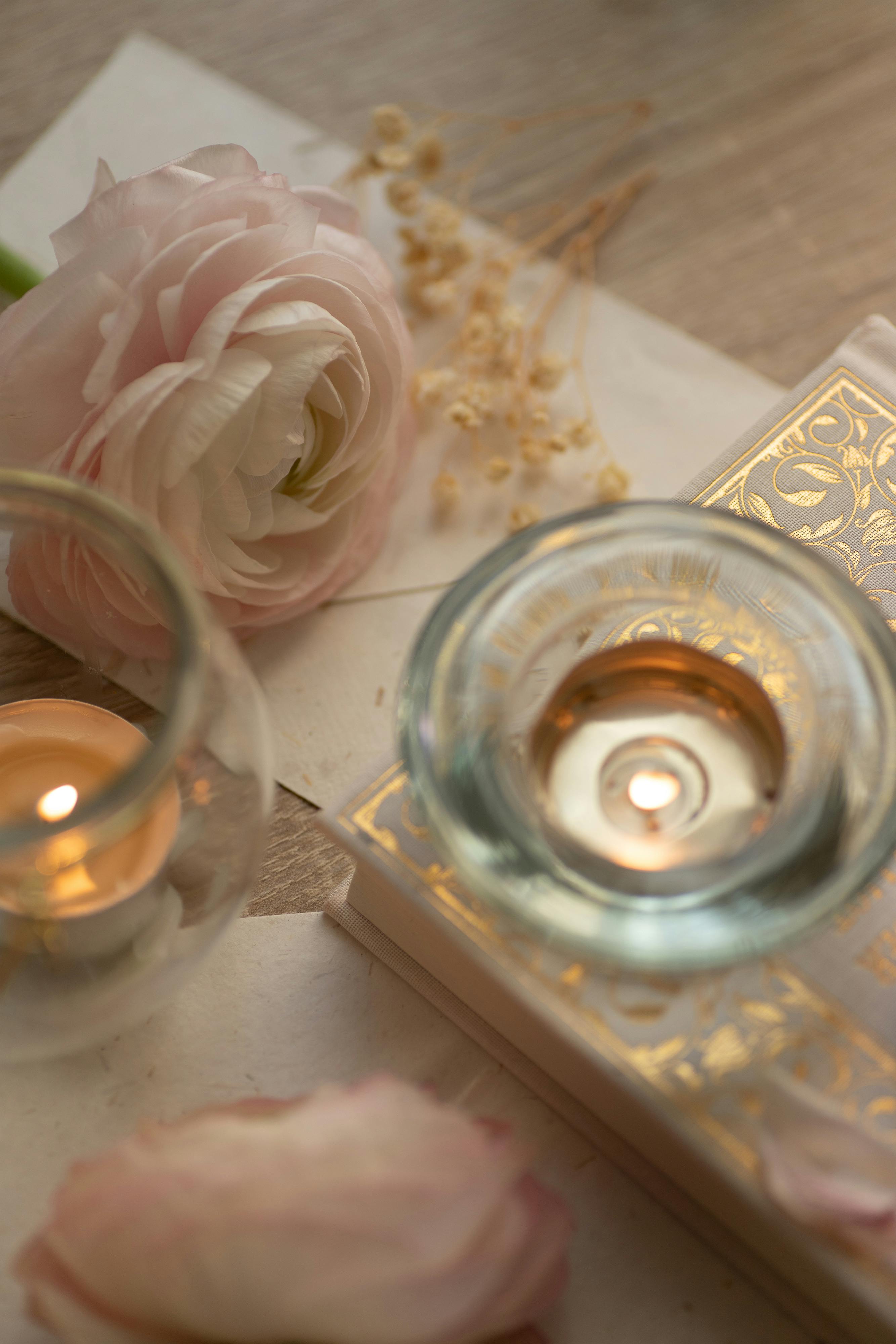 Close-up of Burning Candles an Light Colored Roses · Free Stock Photo