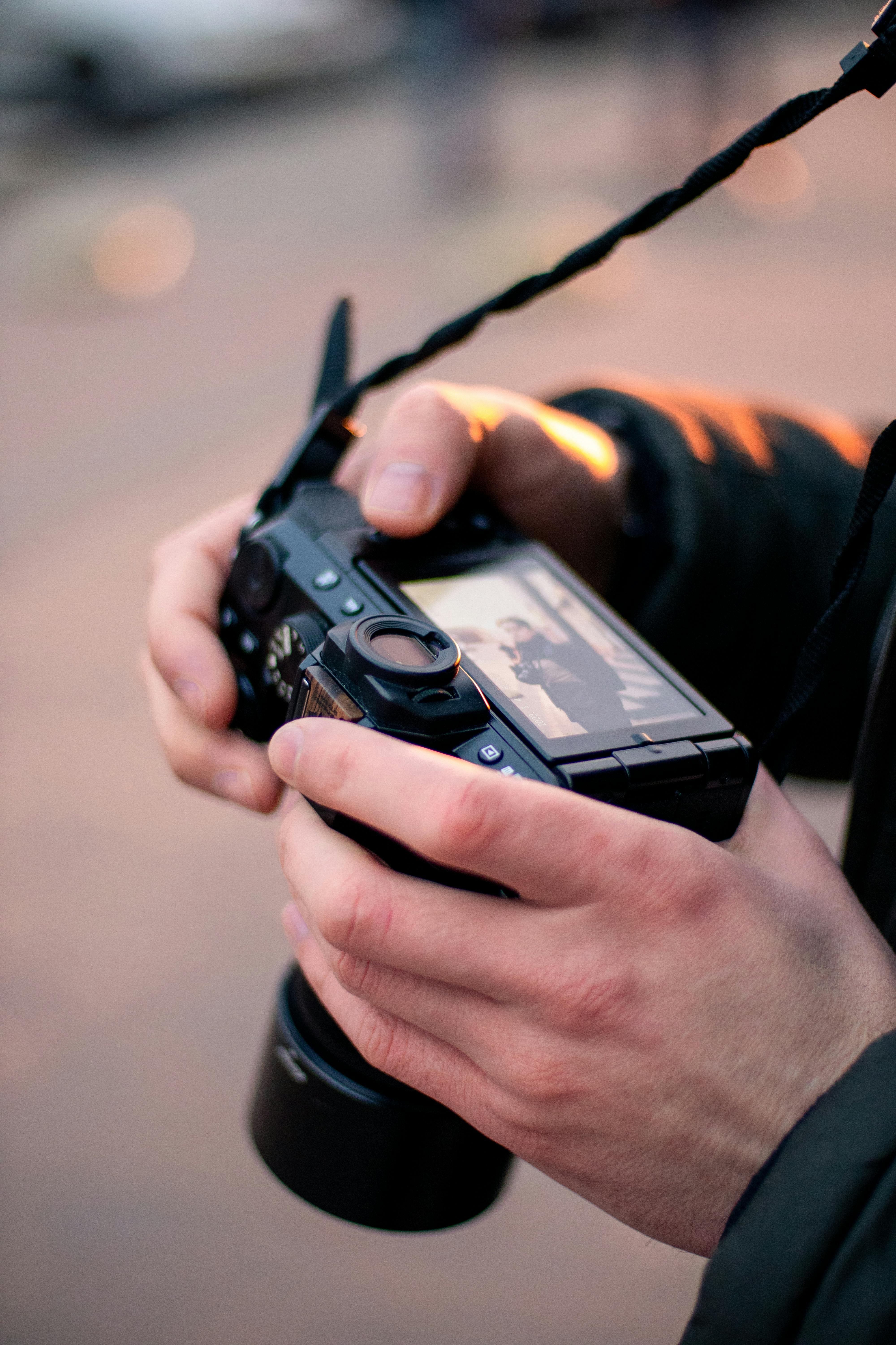 Photographer Looking Through Photos on His Camera · Free Stock Photo