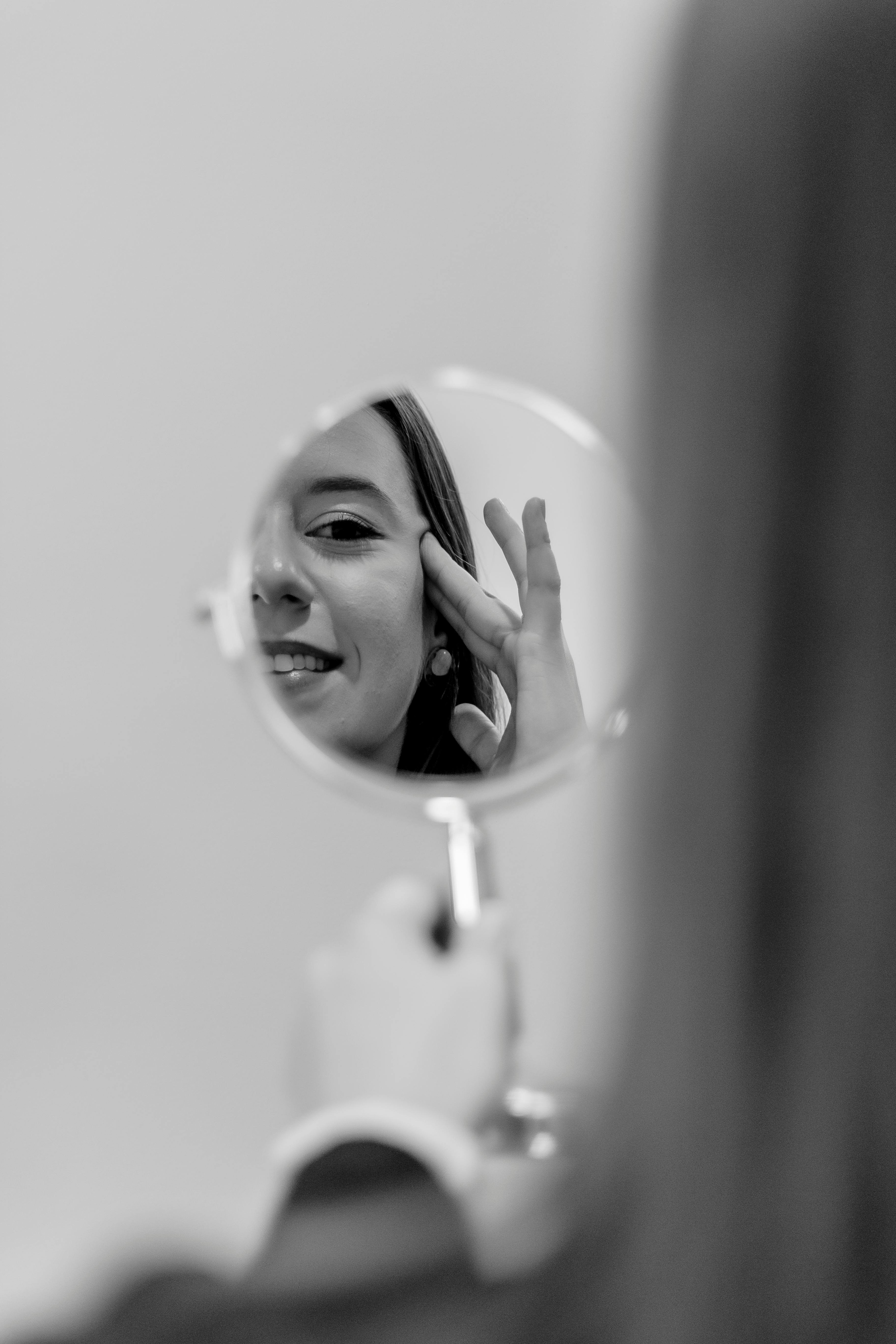 Smiling Woman Reflecting in a Mirror · Free Stock Photo
