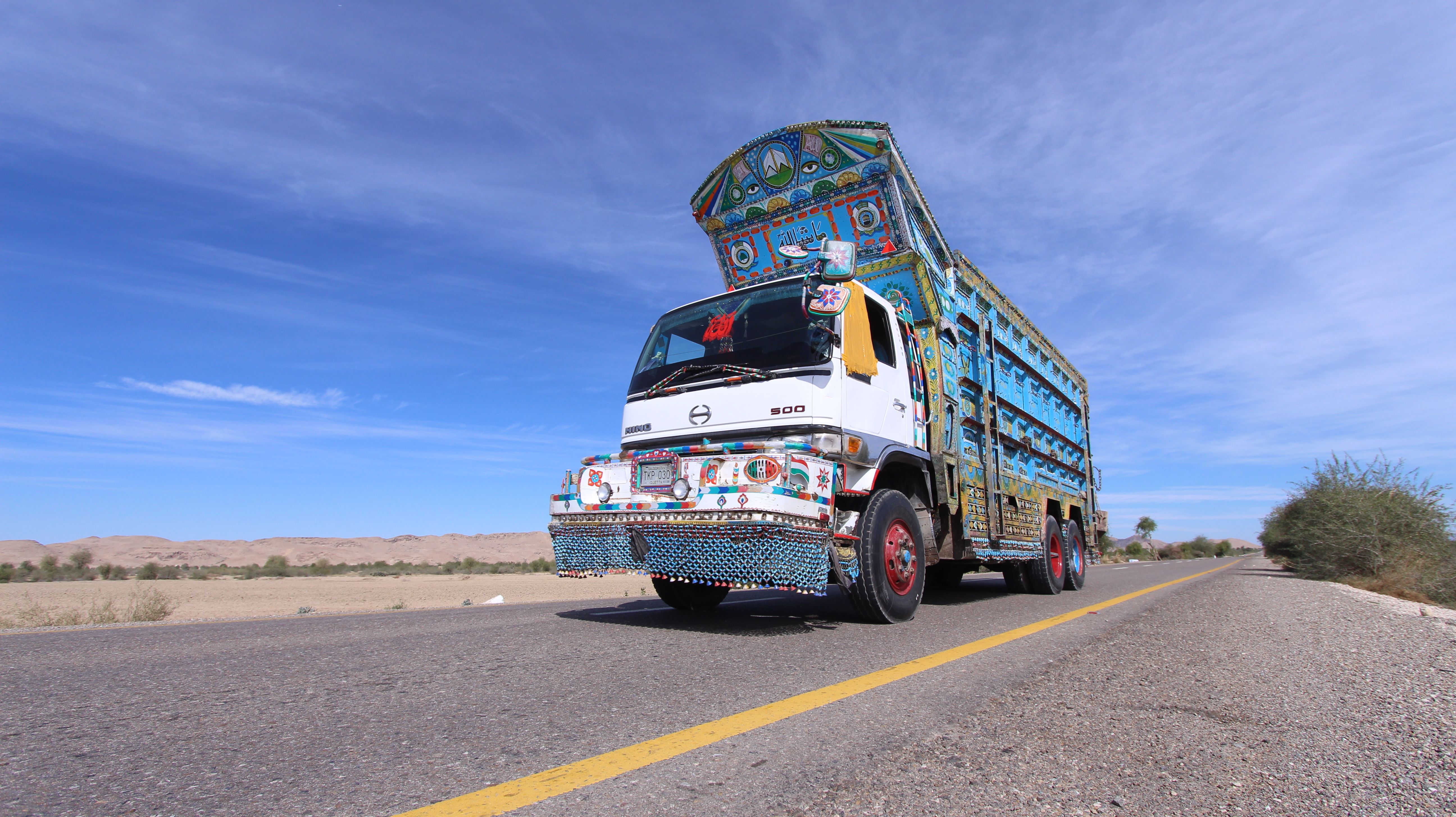 A Colorful, Decorated Truck on an Asphalt Road · Free Stock Photo
