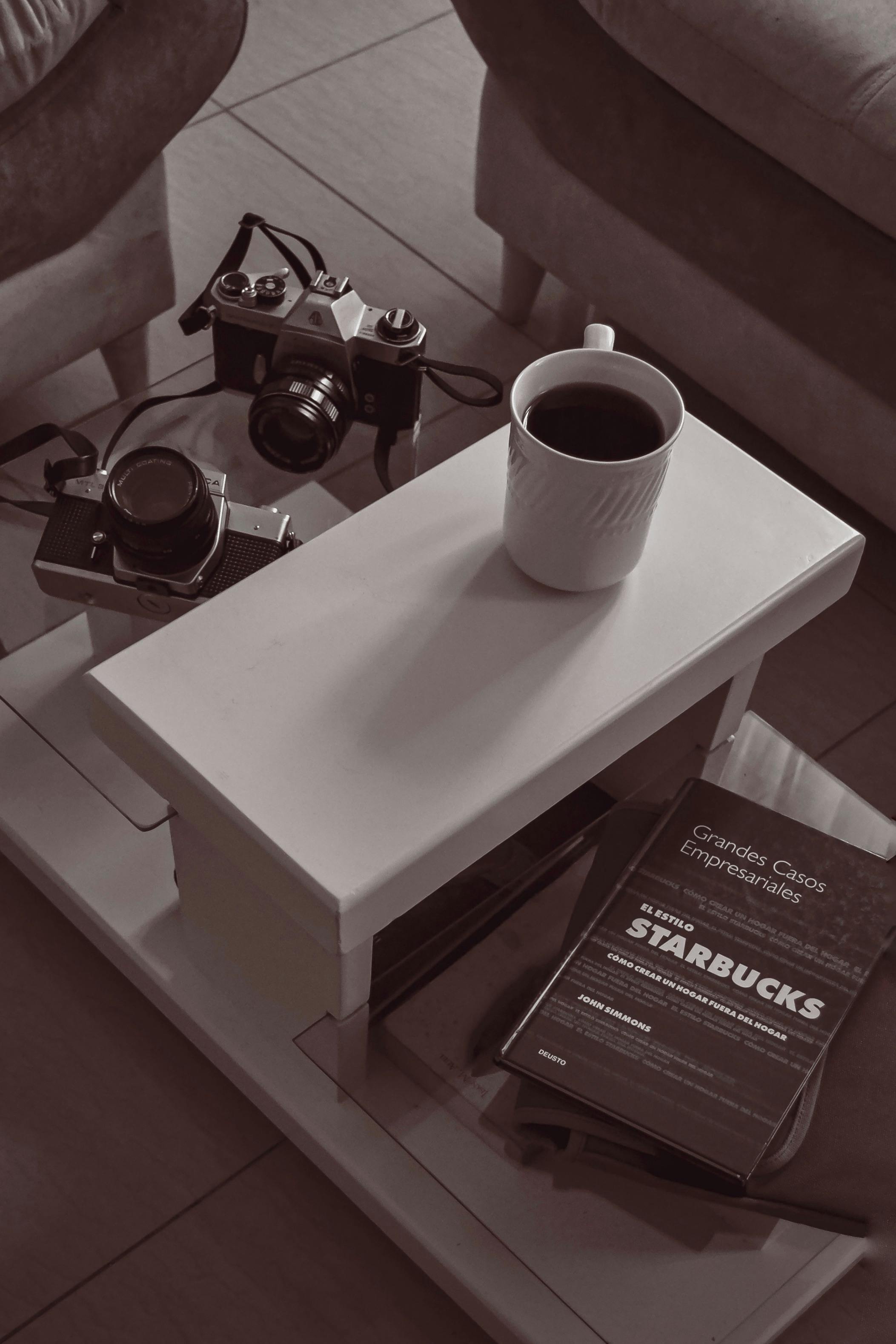 Sepia Toned Photo of a Coffee, Cameras and Books on a Coffee Table ...