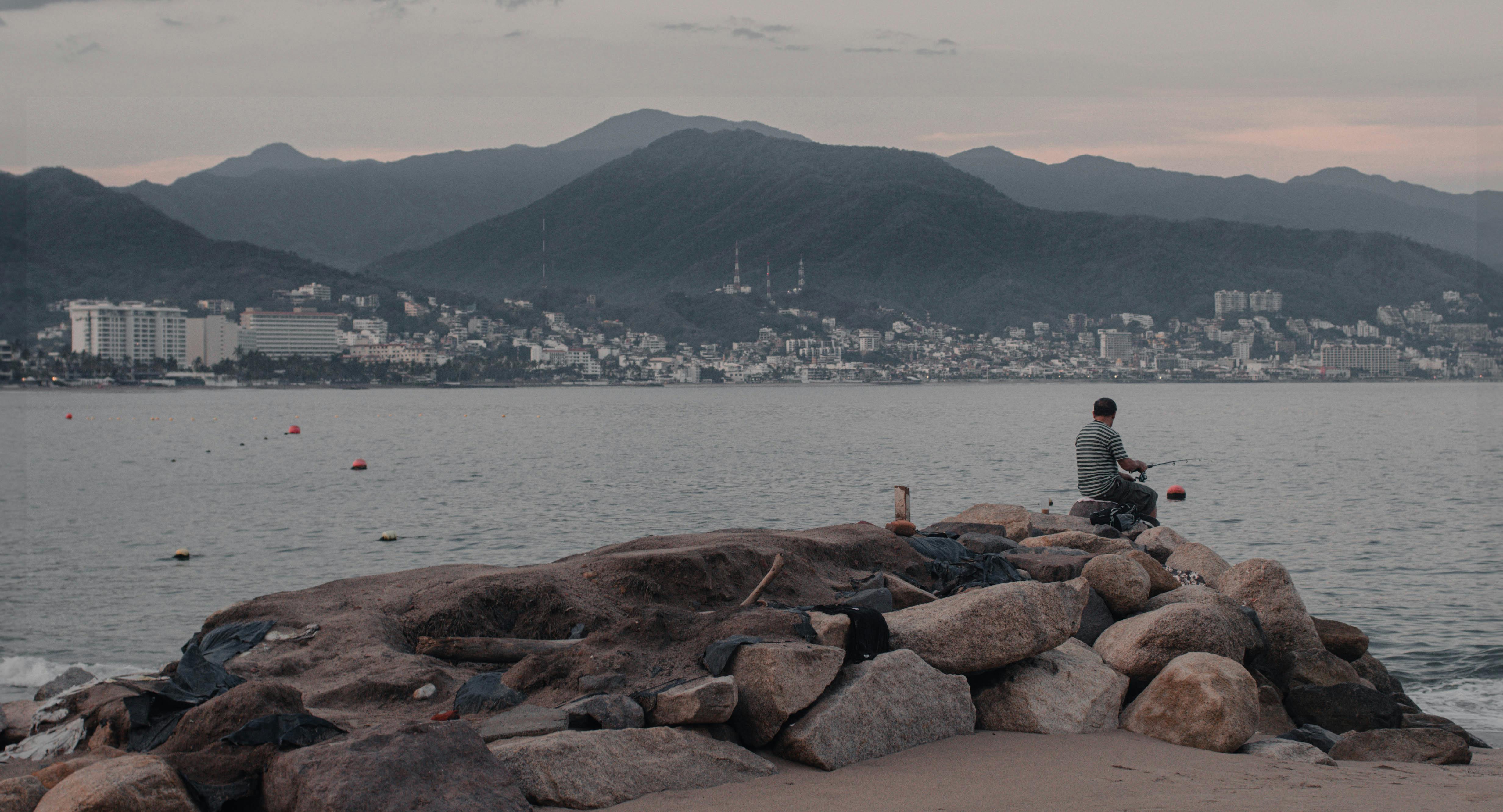 Man Fishing on Rock · Free Stock Photo