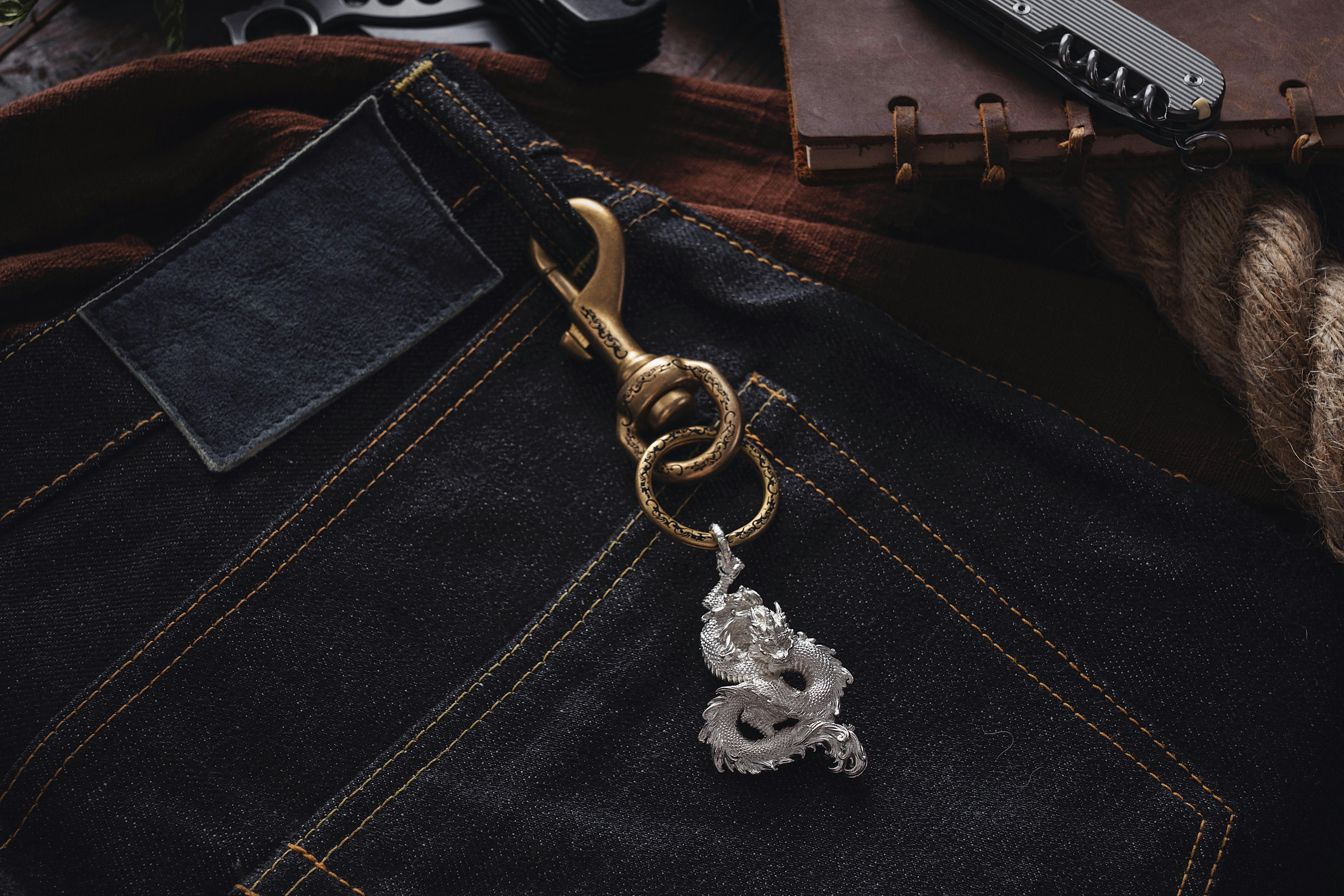 Vintage Dragon Key Chain and Jeans · Free Stock Photo