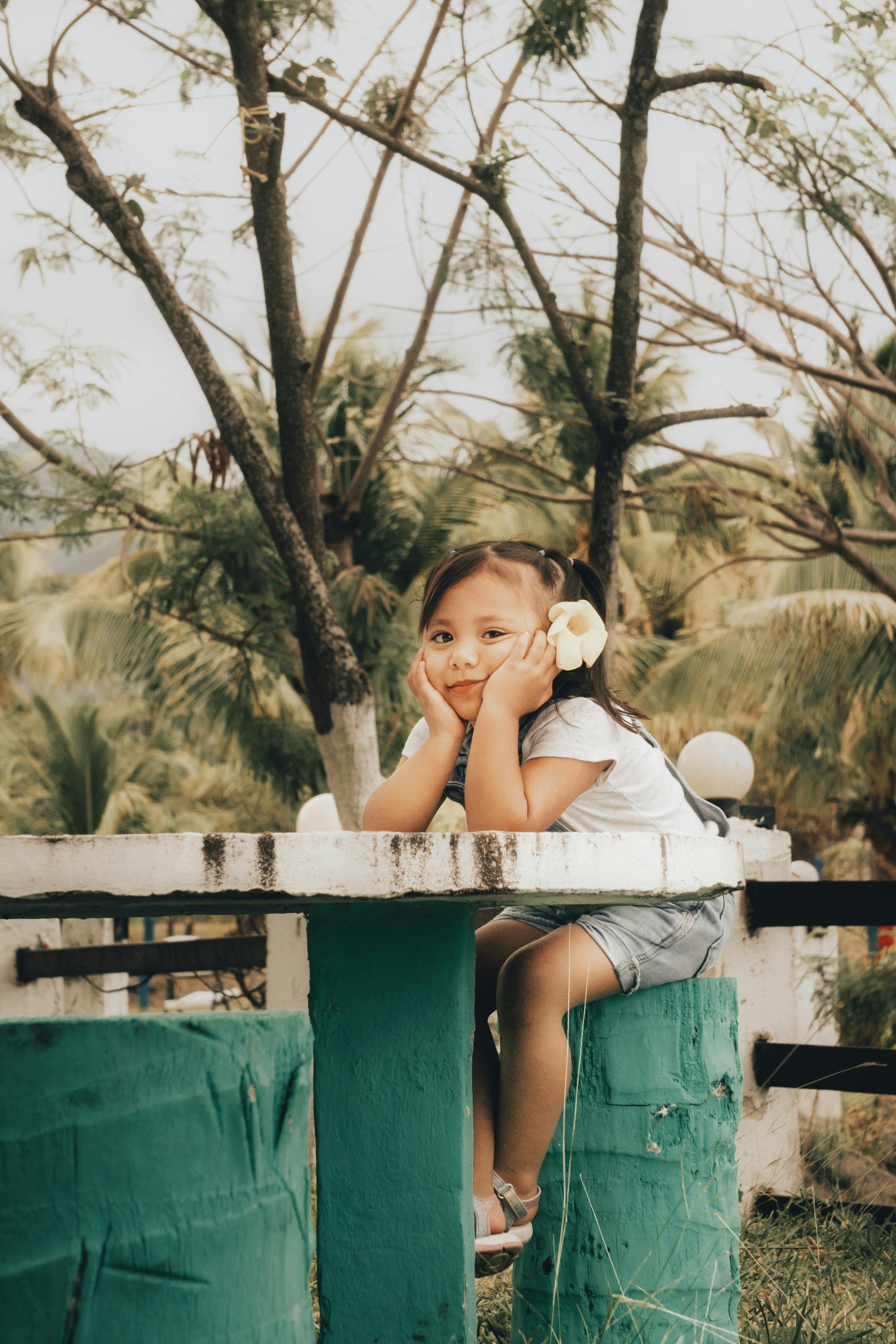 Girl Sitting by Table · Free Stock Photo