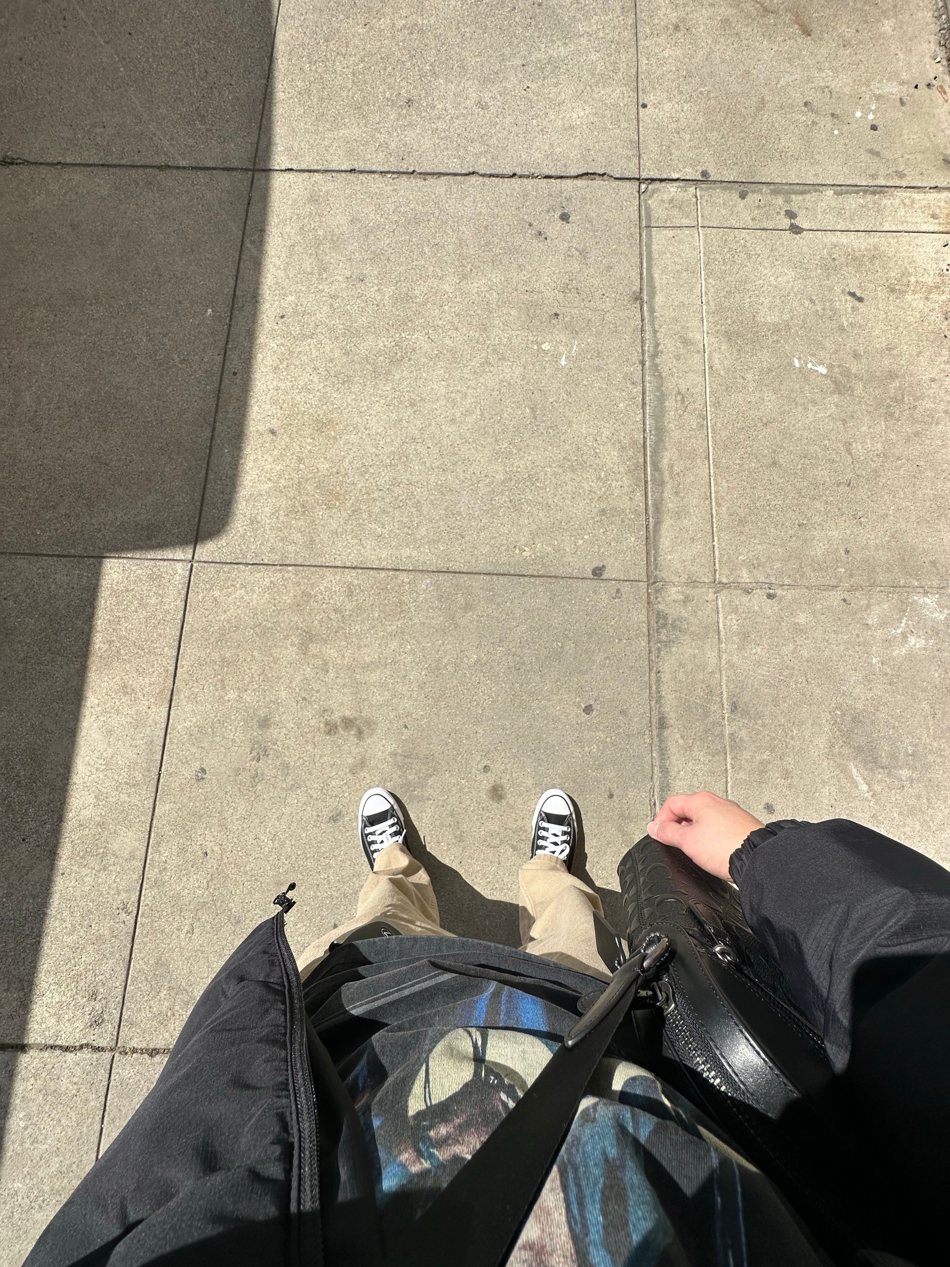 Person Standing on Sunlit Pavement · Free Stock Photo
