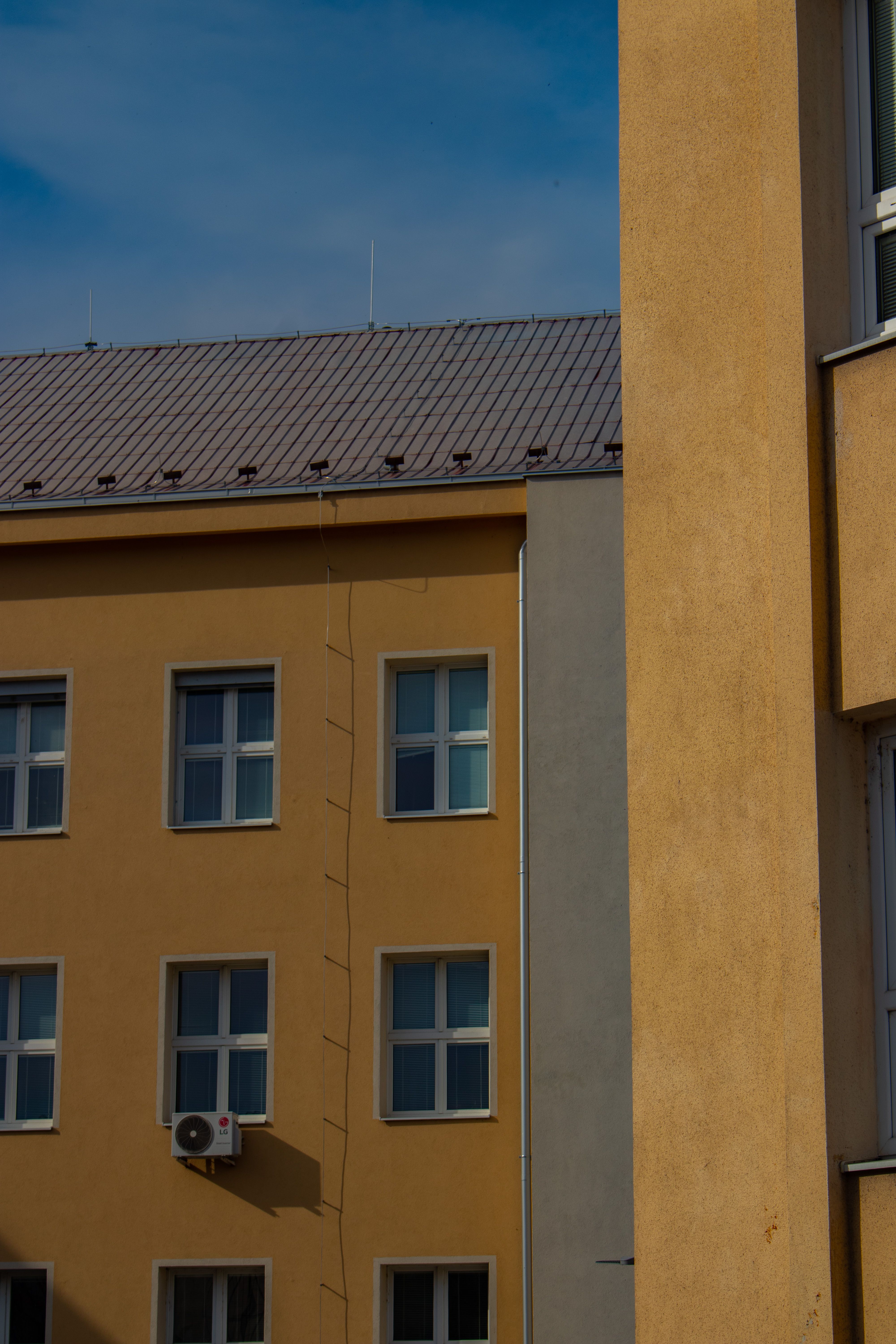 Facade of a Hostel Building under Blue Sky · Free Stock Photo