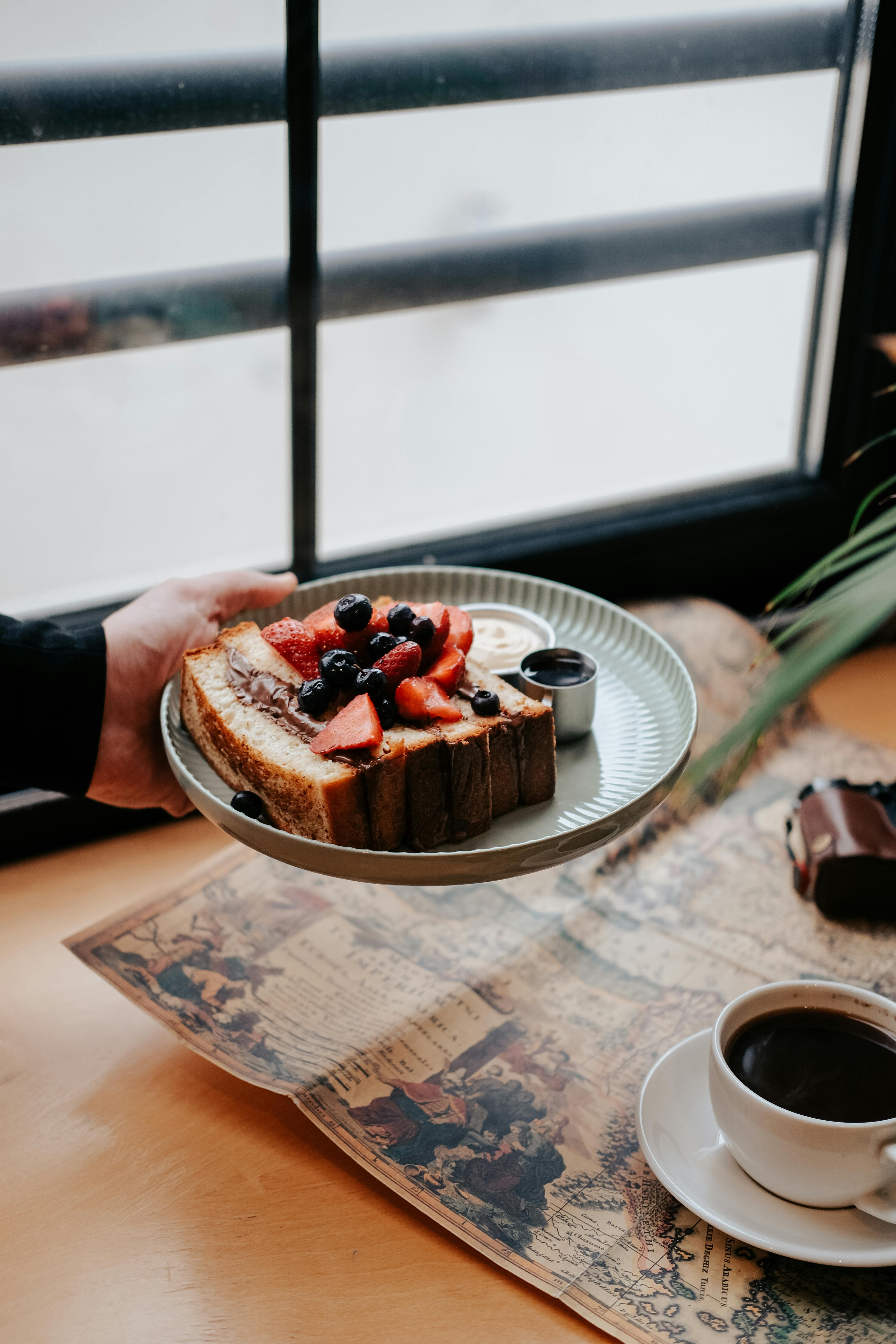 Woman Hand Holding Spoon over Cakes · Free Stock Photo