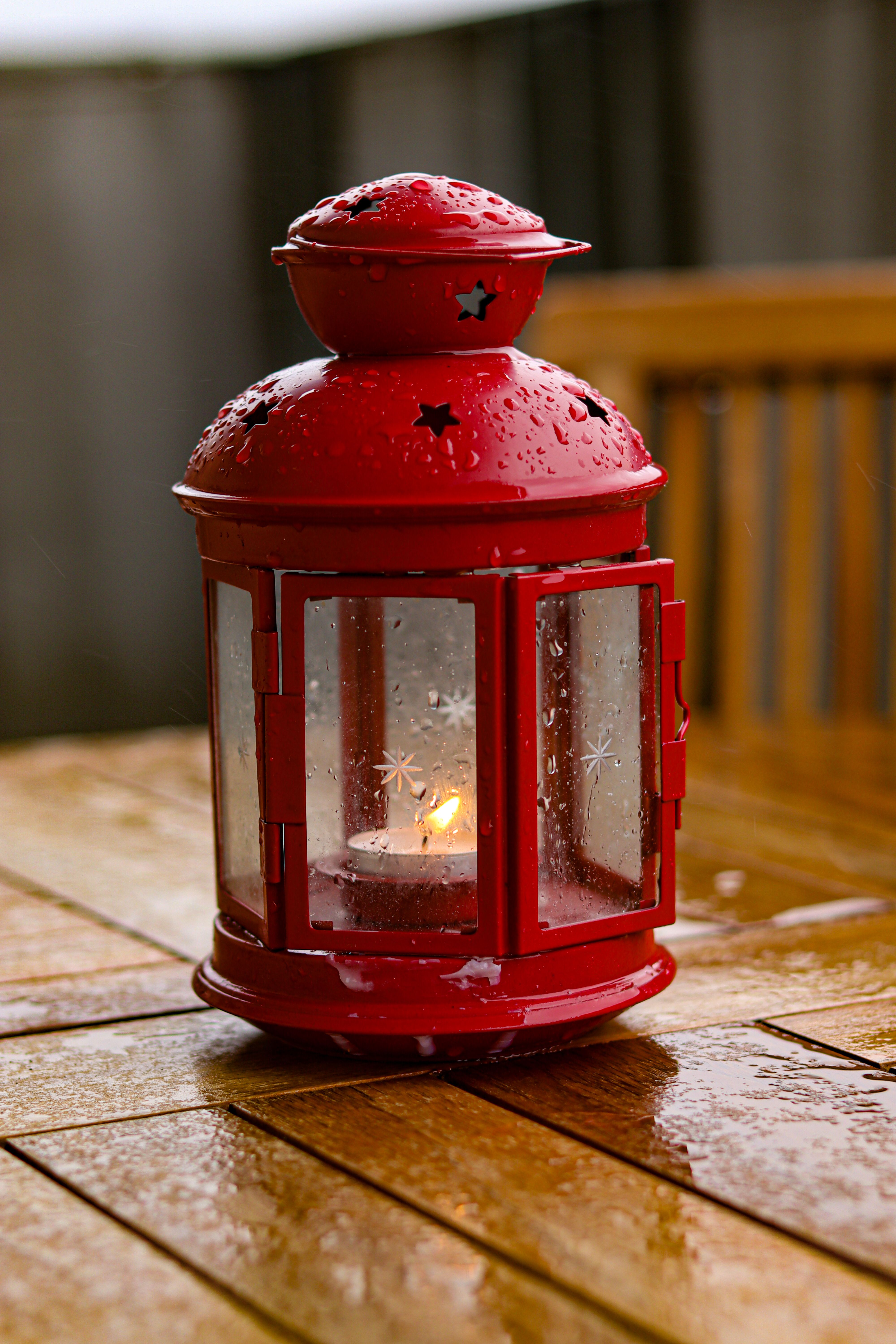 A Candle Burning inside a Red Lantern on a Table during Rainfall · Free ...