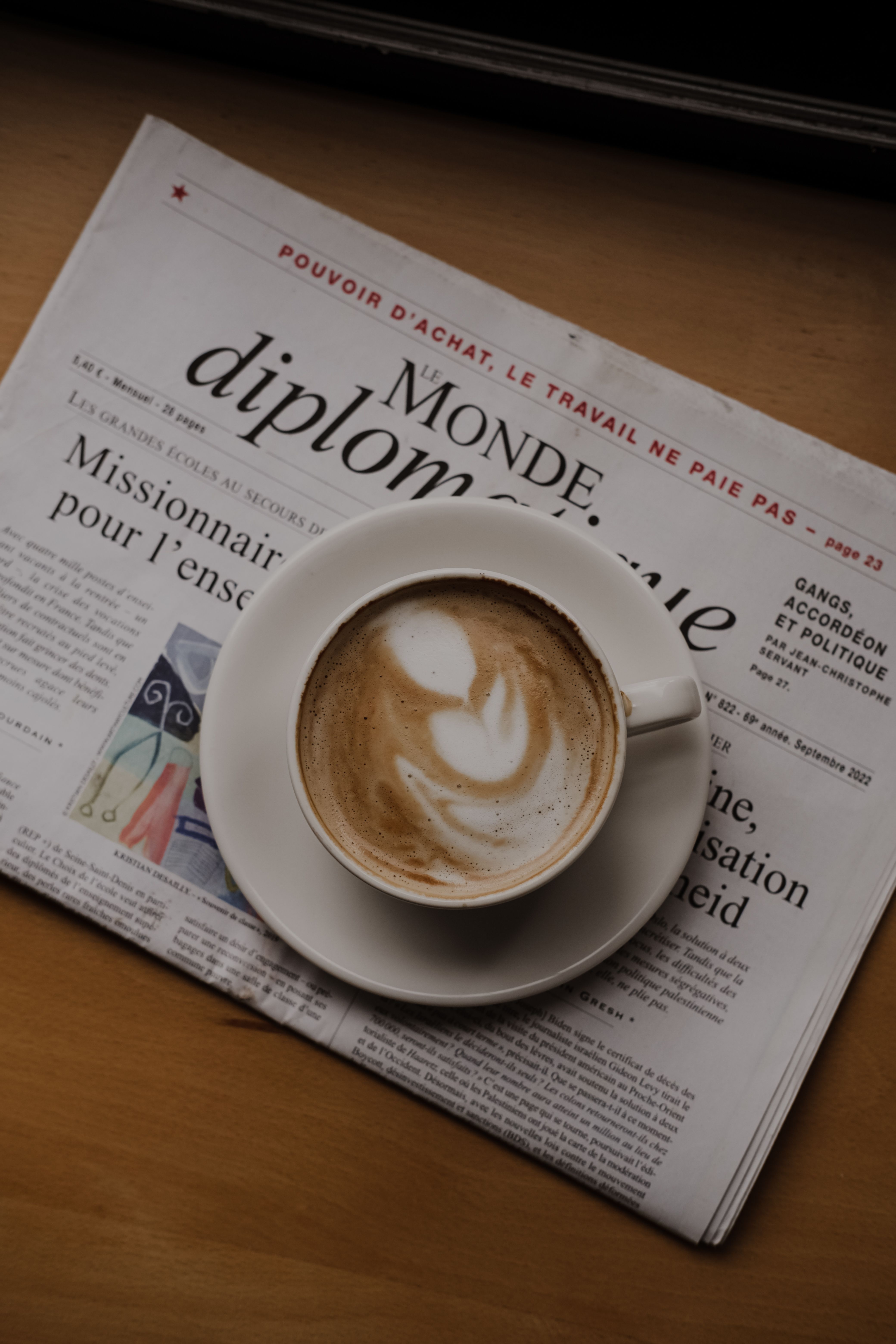 Newspaper and Glass on Brown Wooden Table · Free Stock Photo