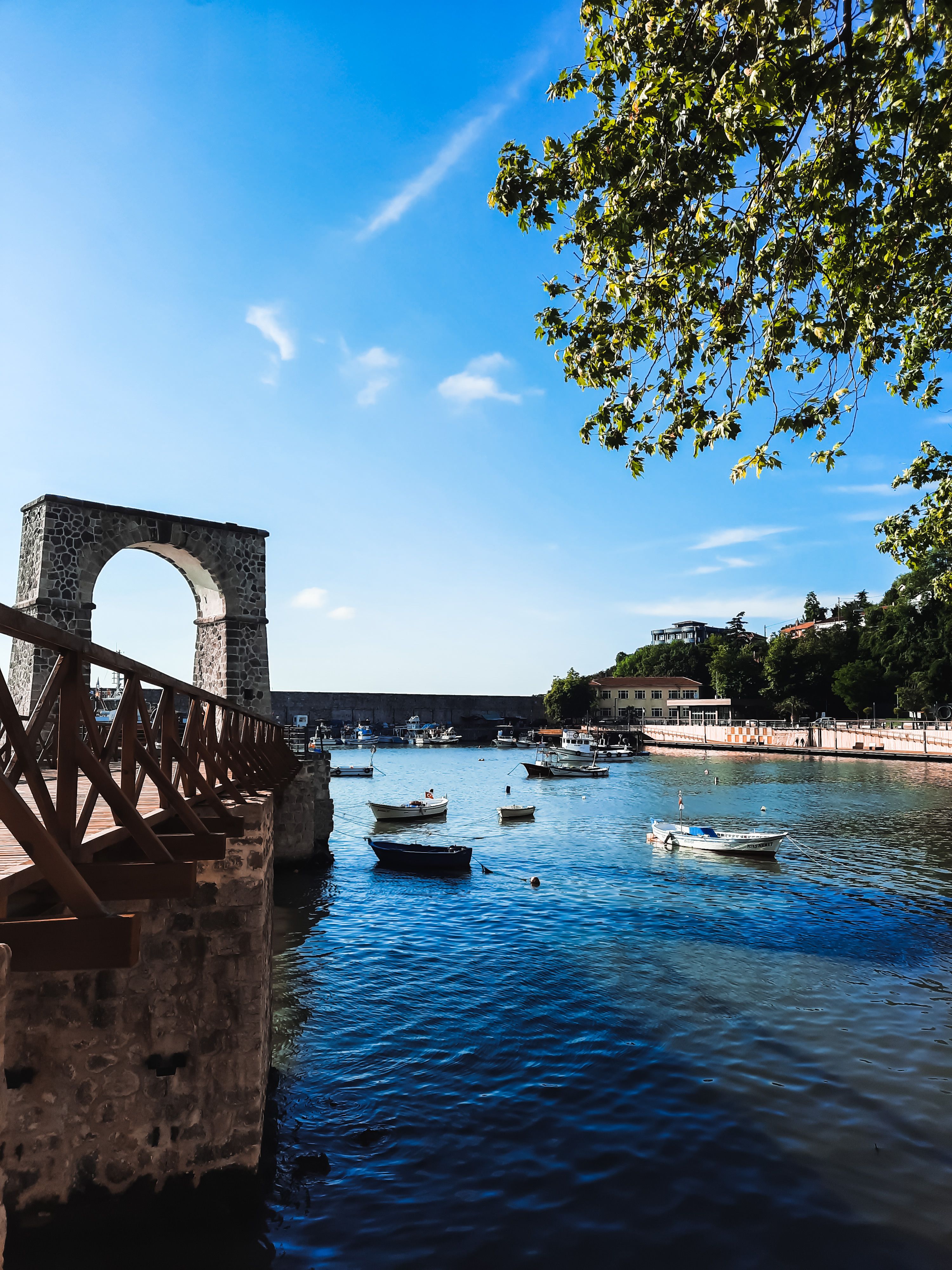 Boats near the Harbor and a Stone Pier · Free Stock Photo