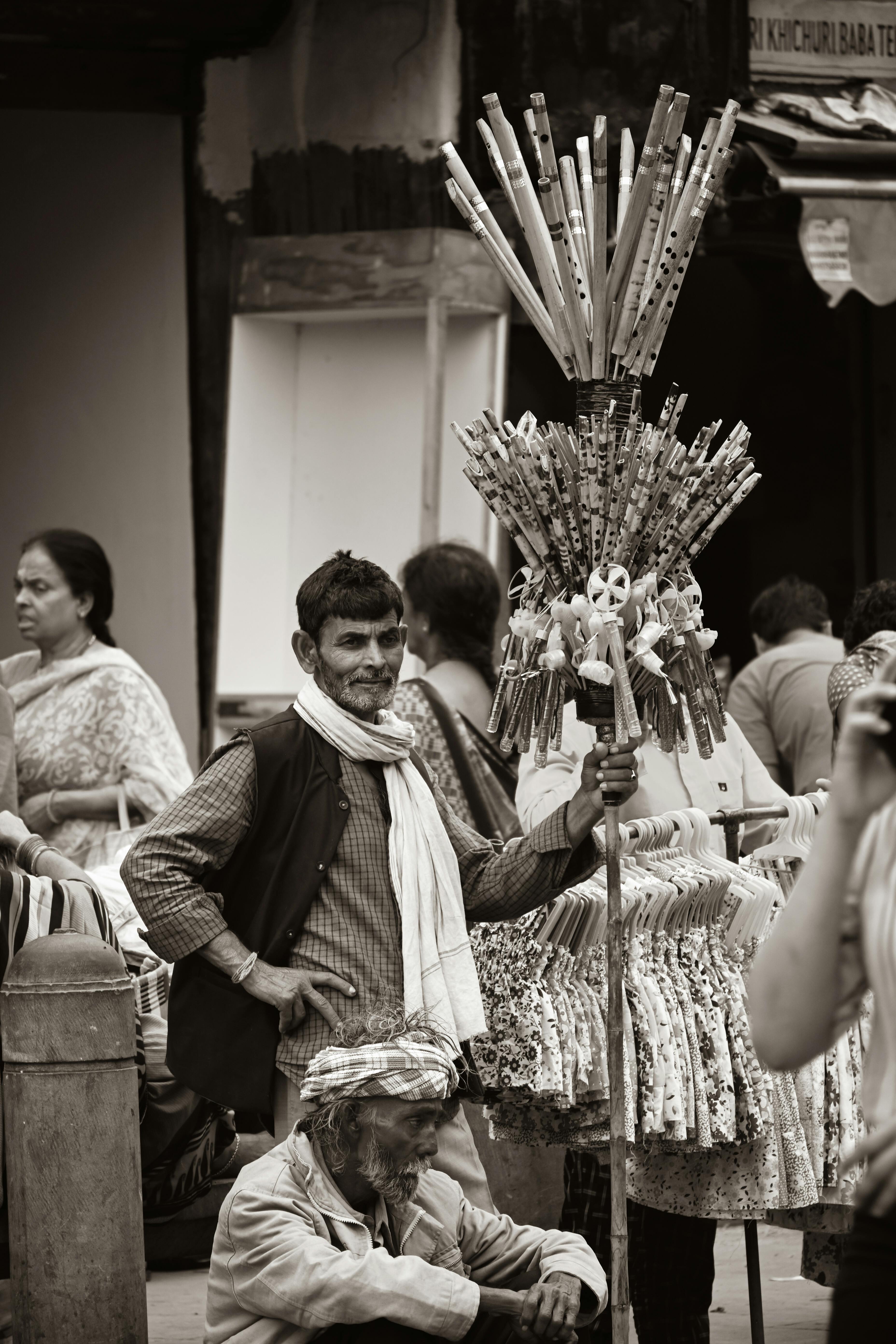 Man Standing near Box with Books on Street · Free Stock Photo