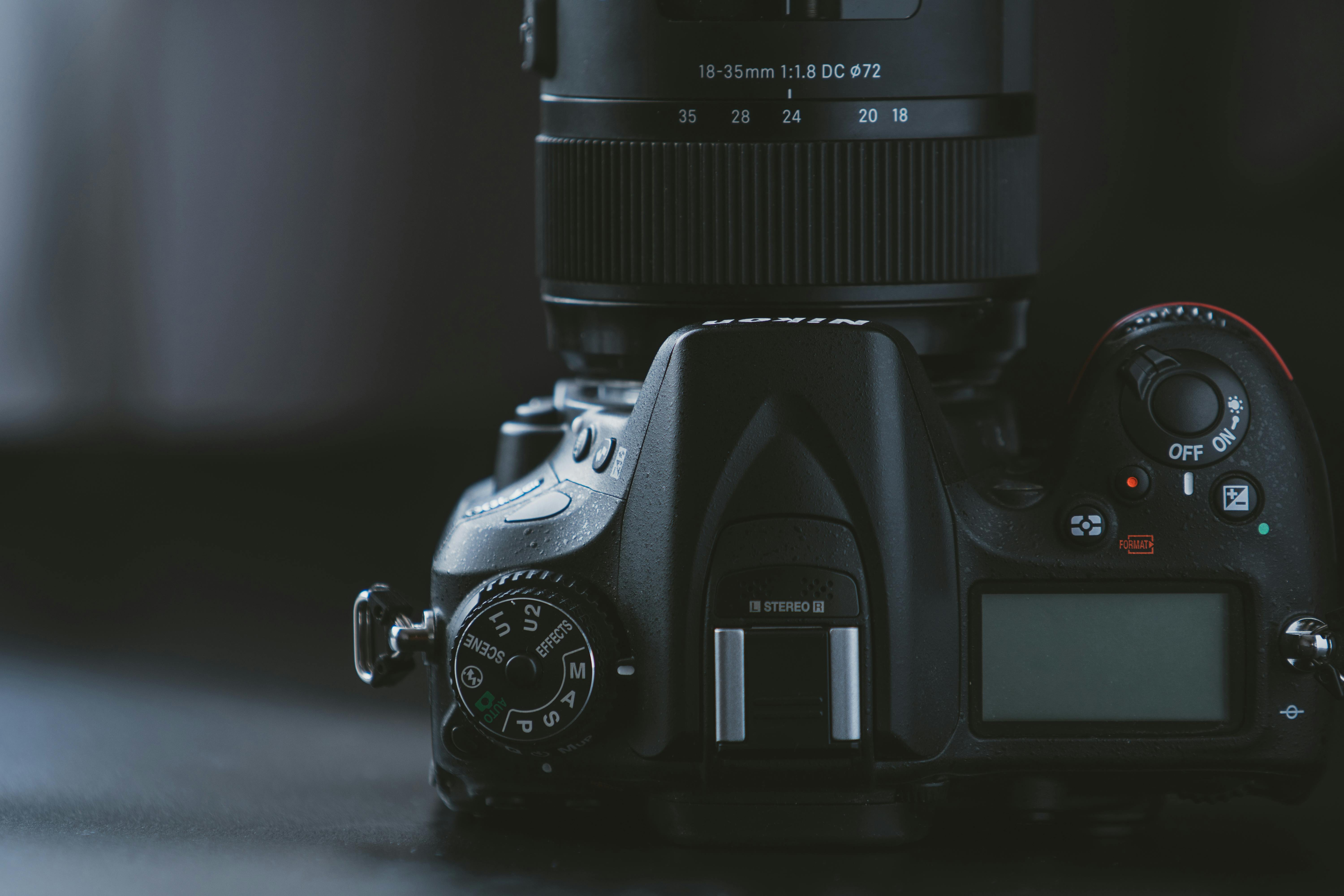 Black Dslr Camera on White Surface · Free Stock Photo