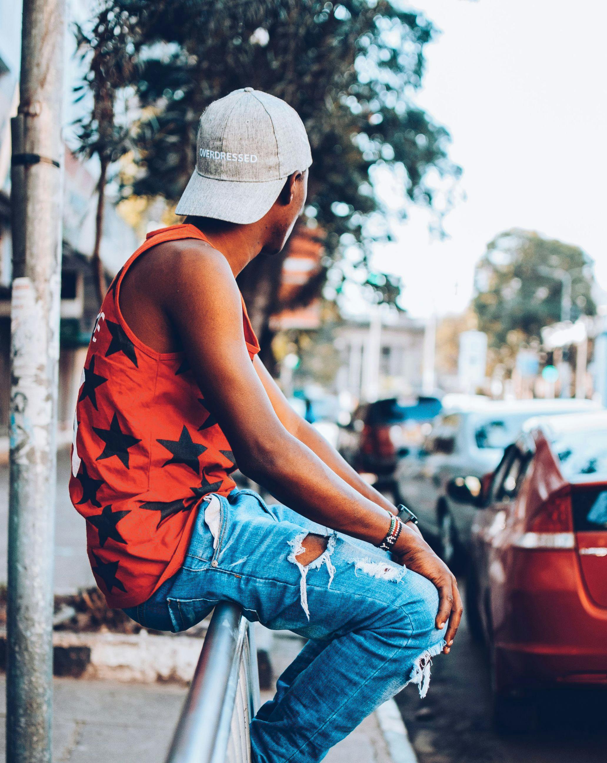 Man Sitting On Railing · Free Stock Photo