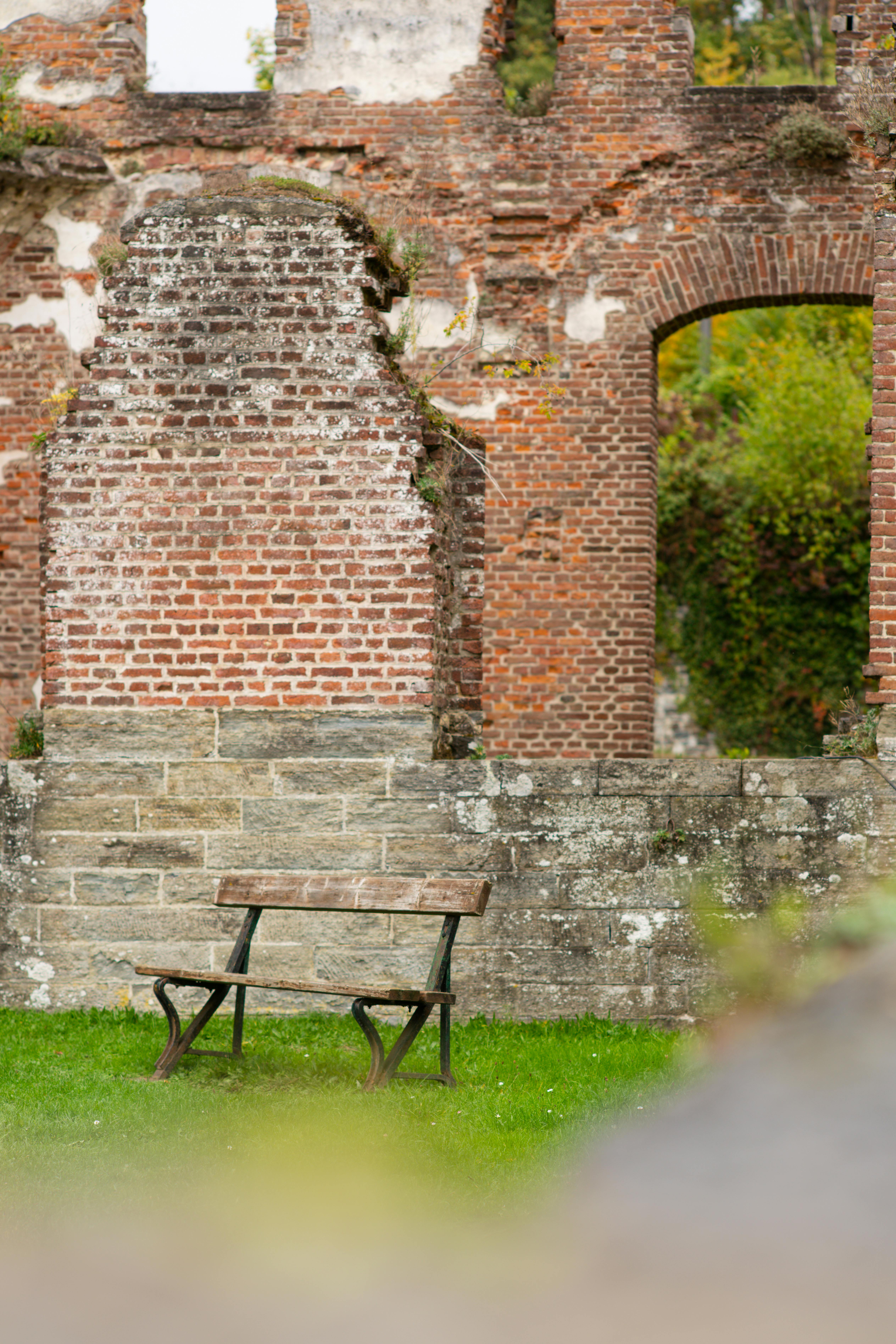 An Empty Bench in front of the Ruins · Free Stock Photo