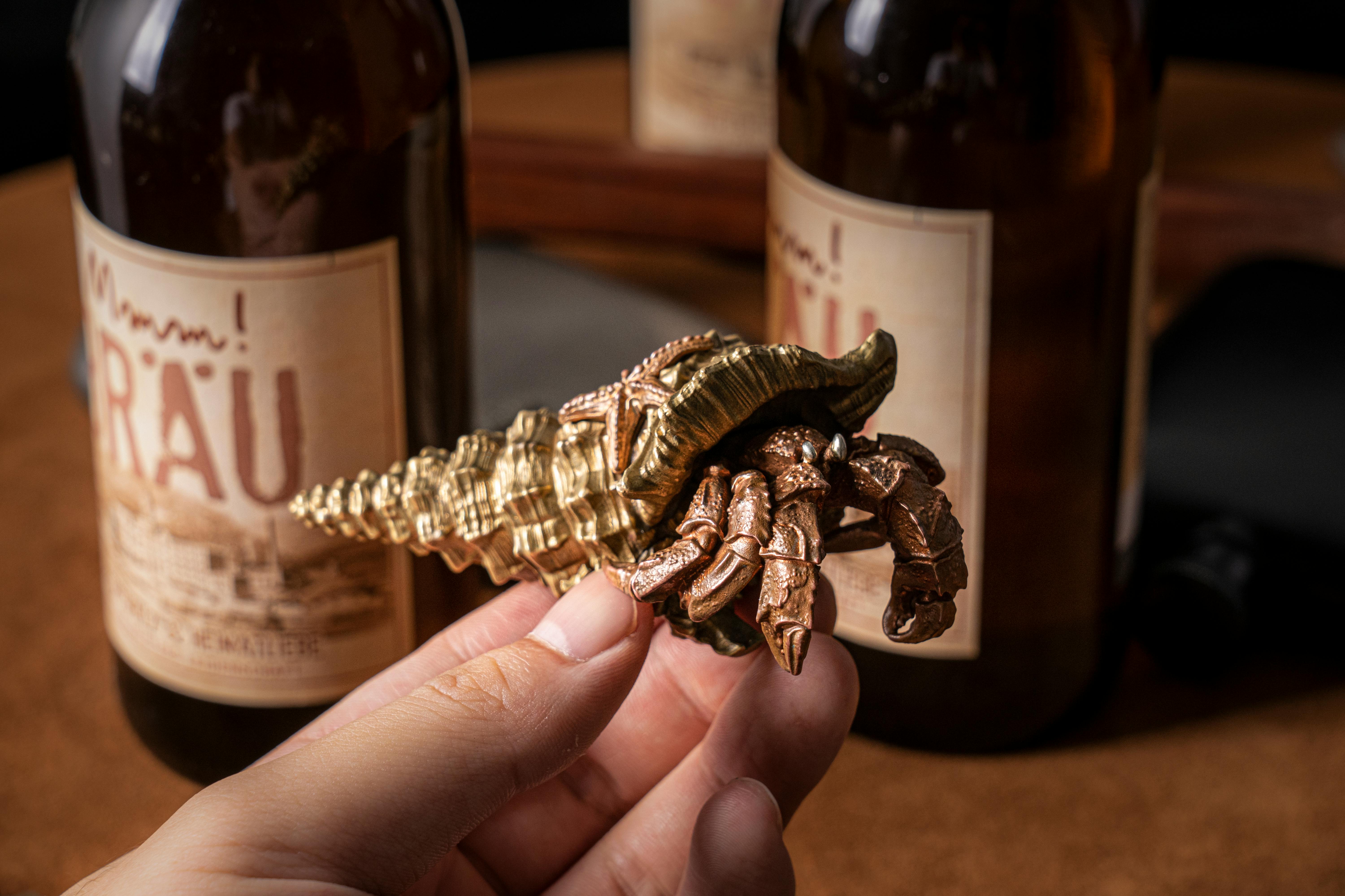 Fingers Holding Golden Snake Eating Crab · Free Stock Photo