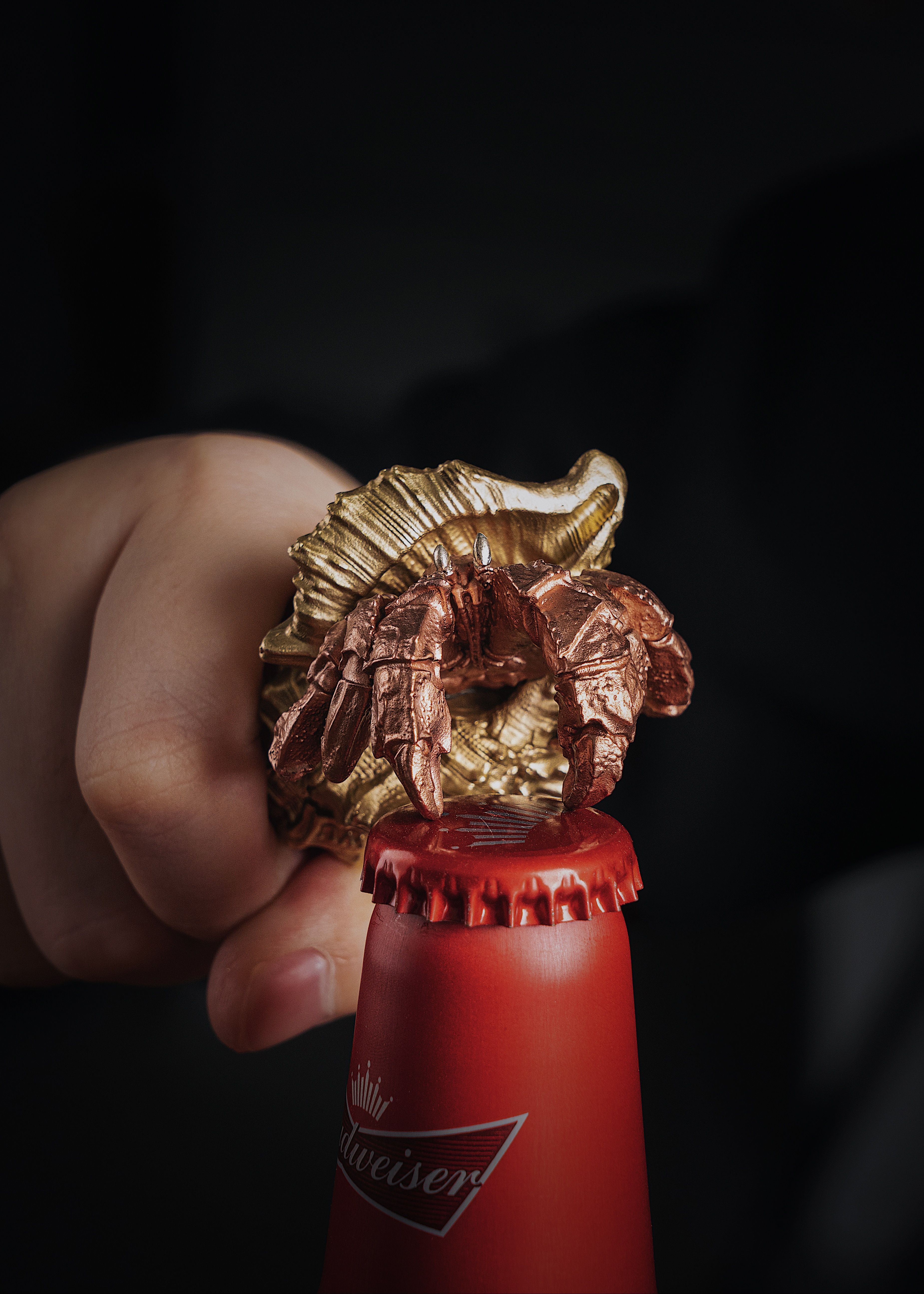 Hand Holding Golden Cap Opener · Free Stock Photo