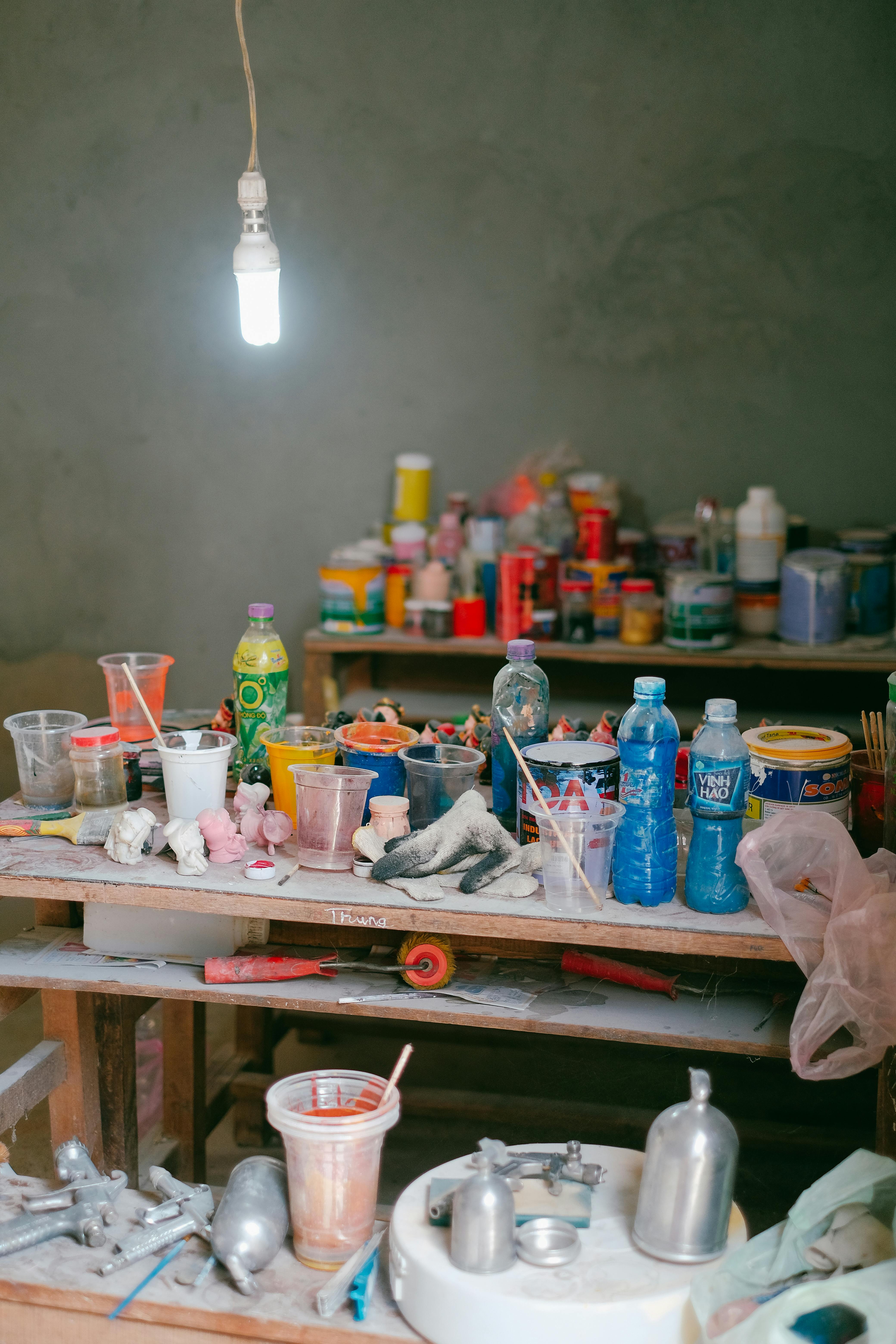 Messy Table with Bottles, Cups and Paints · Free Stock Photo