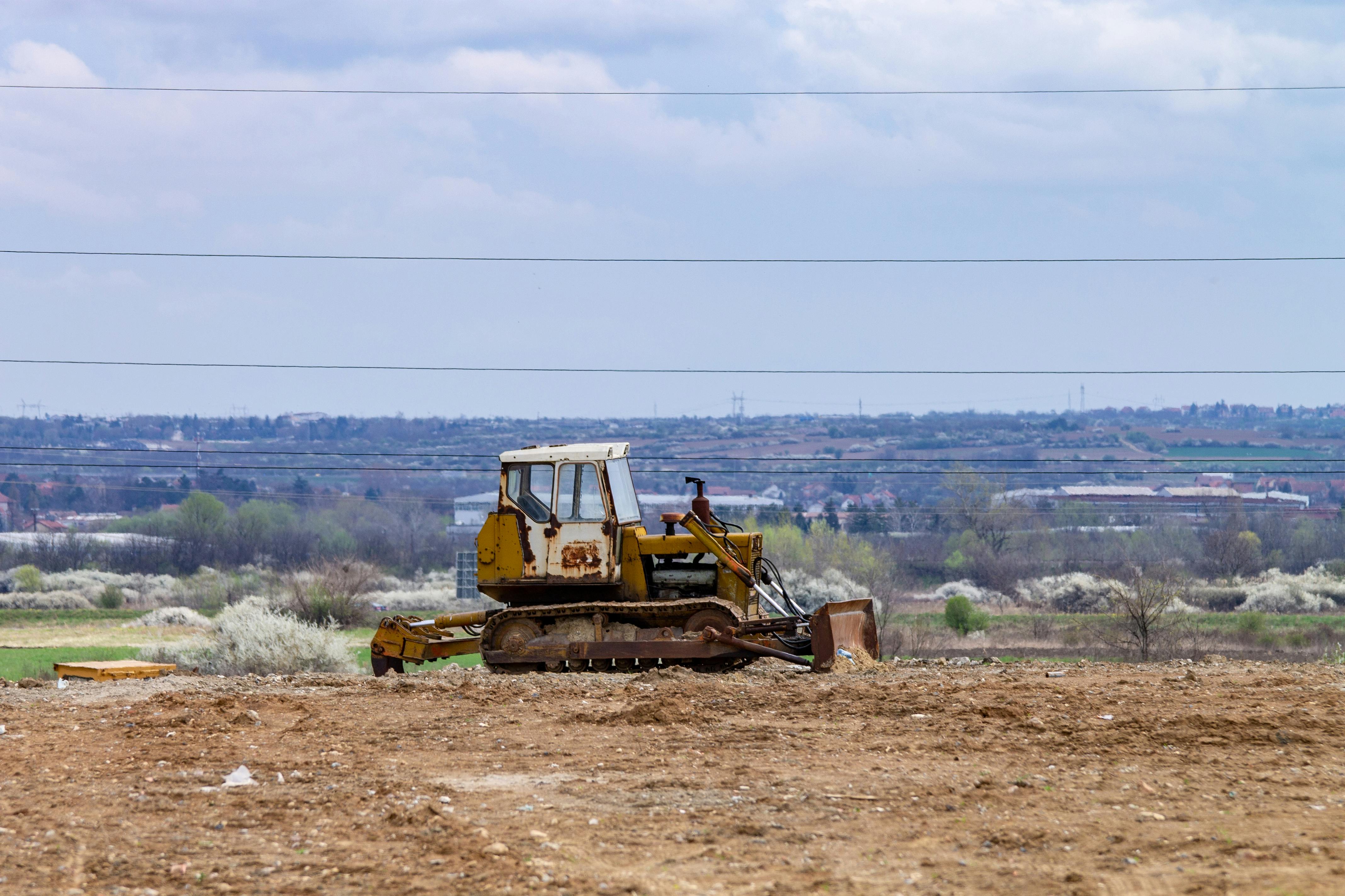 A Bulldozer Digging on the Beach · Free Stock Photo