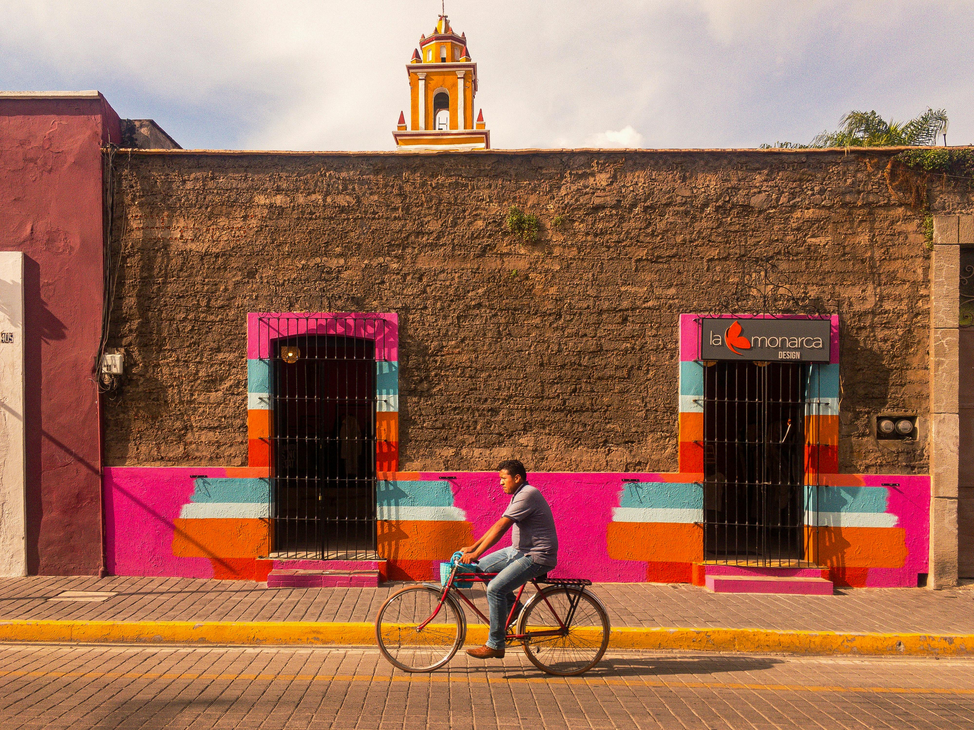 Man Riding on a Bike on a Paving Stone Street · Free Stock Photo