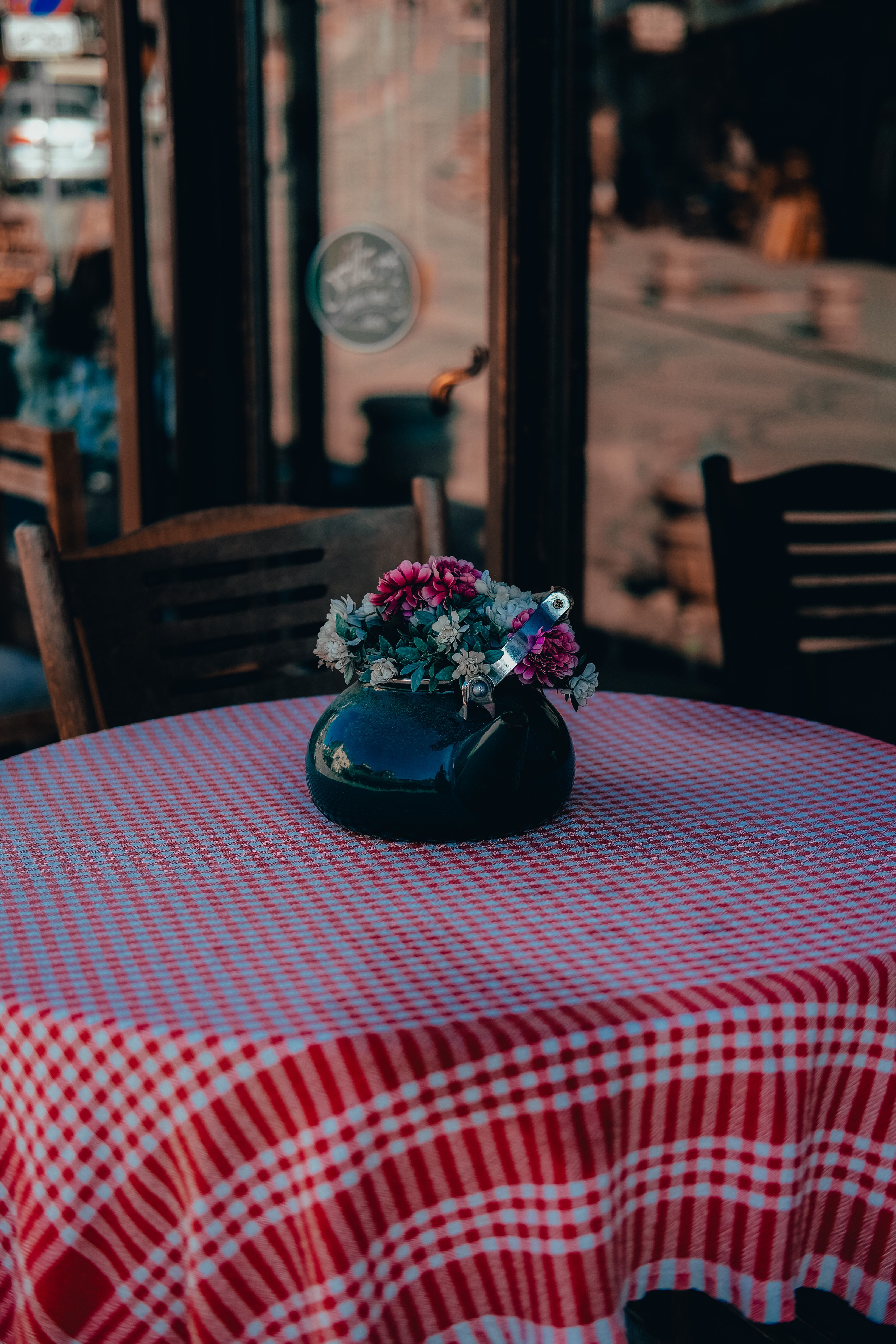 Flowers on Sidewalk Cafe Table · Free Stock Photo
