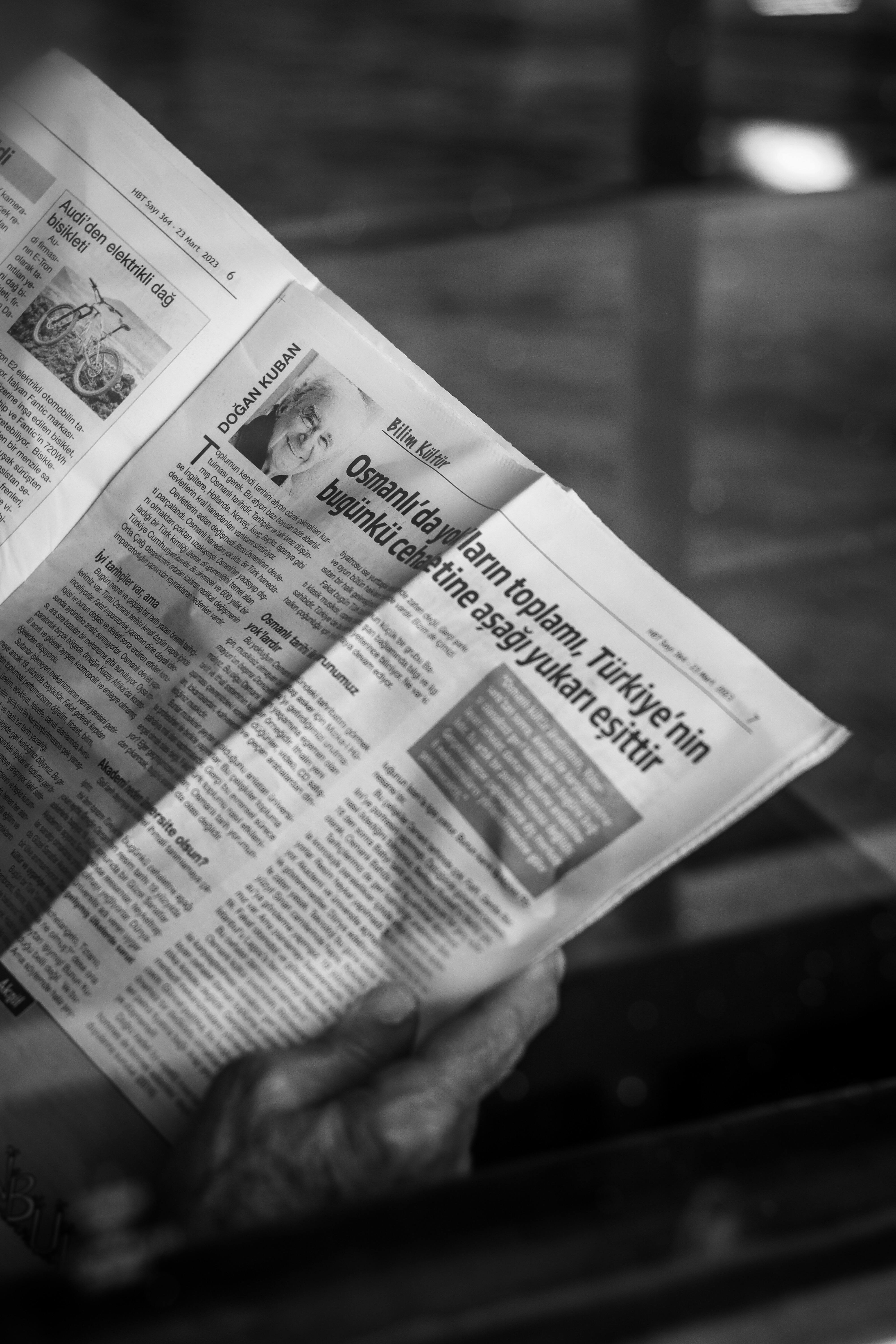 Person in Jacket Holding Magazine in Hand · Free Stock Photo