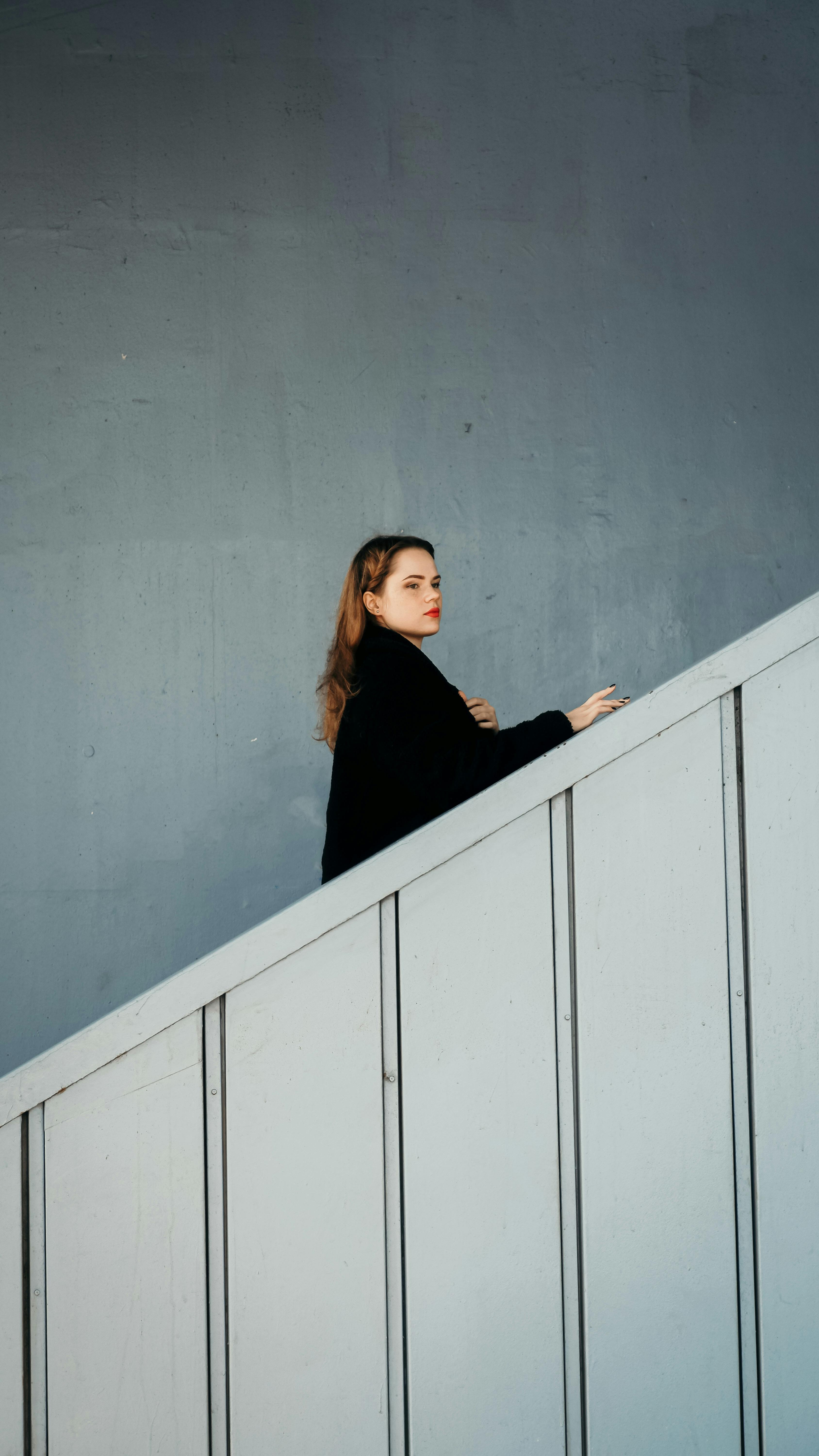 Person Walking On Stairs In Greyscale Photograph · Free Stock Photo