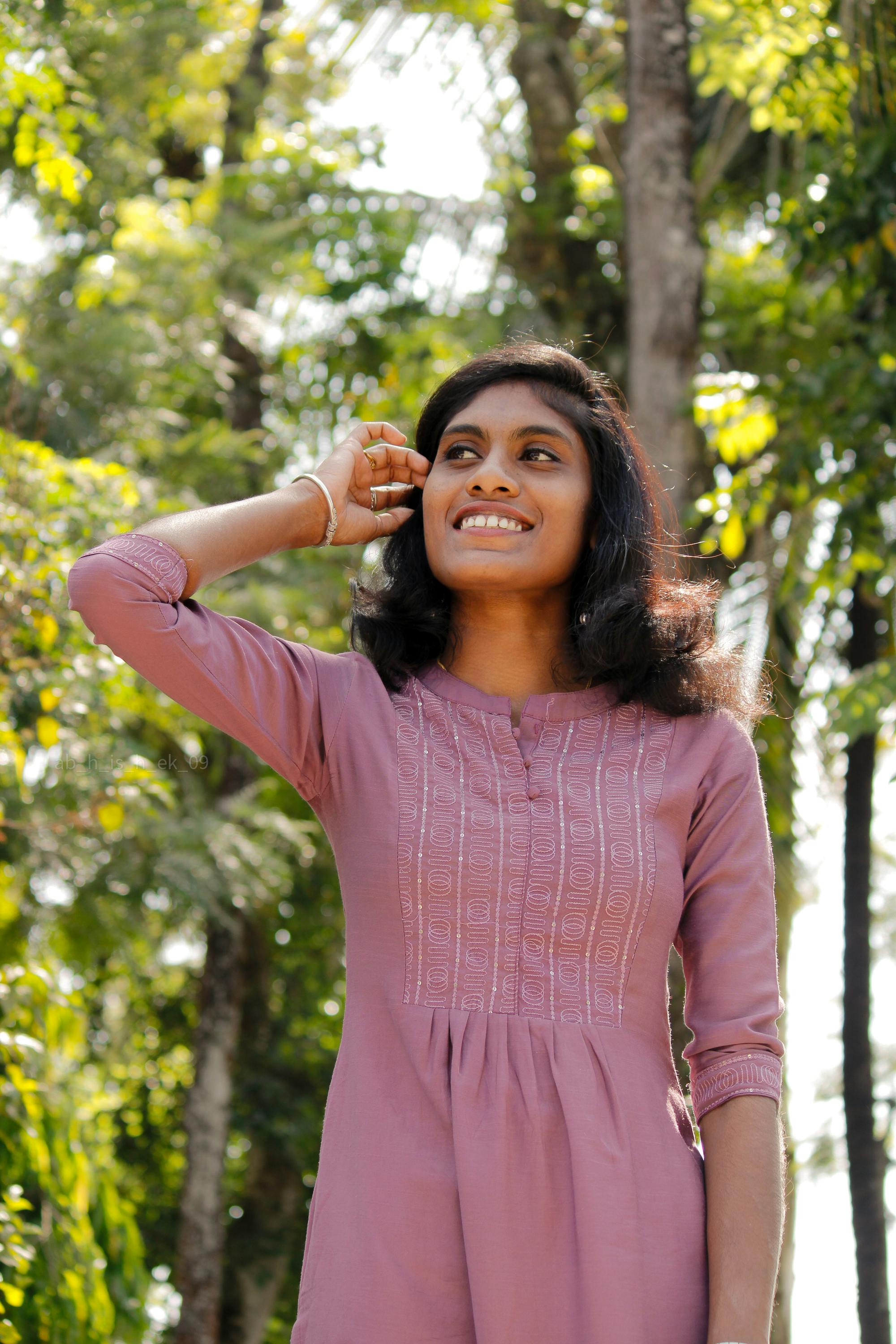 Beautiful Woman in a Blue Dress Fixing her Hair · Free Stock Photo