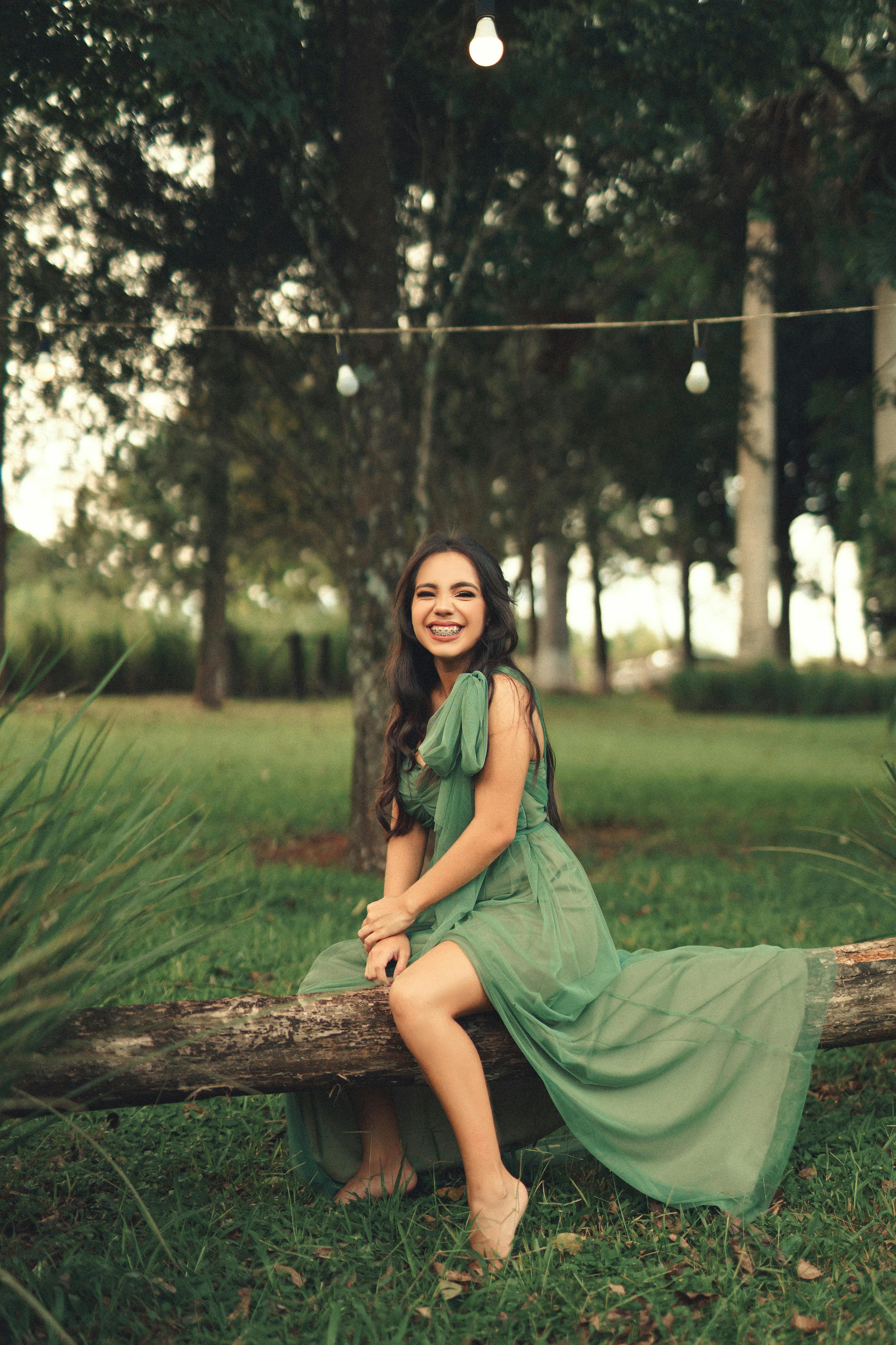 Woman Sitting Astride on a Tree Trunk · Free Stock Photo
