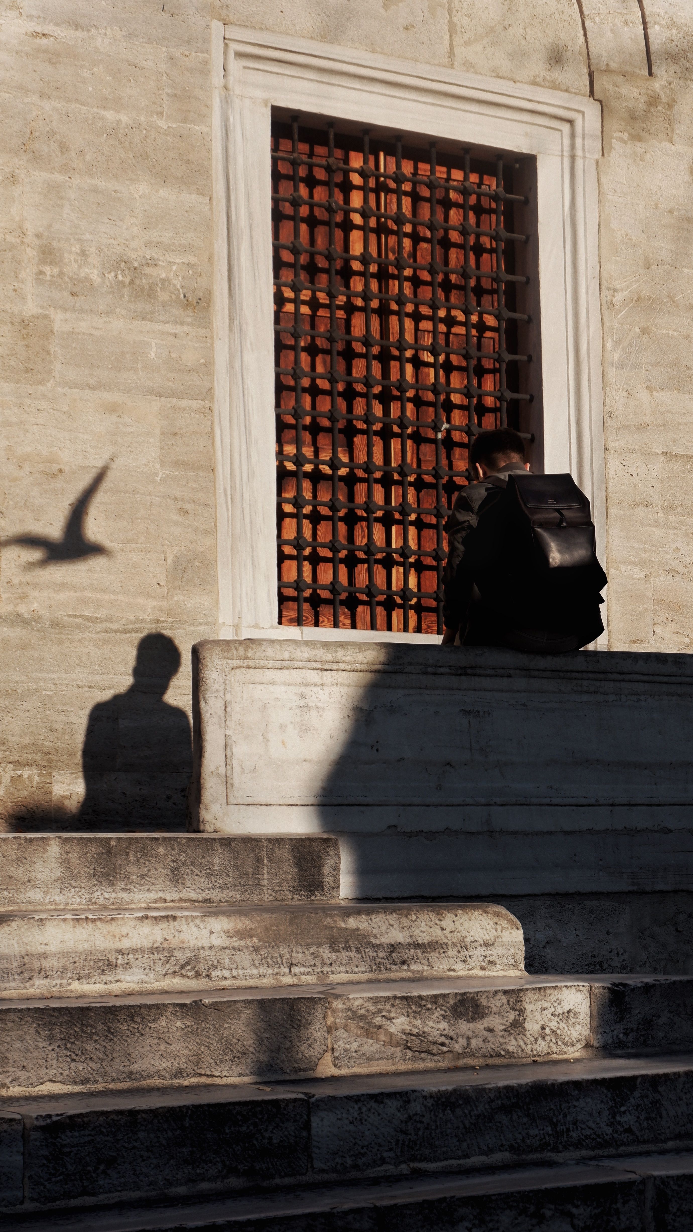 Shadow of a Man Sitting on a Wall · Free Stock Photo