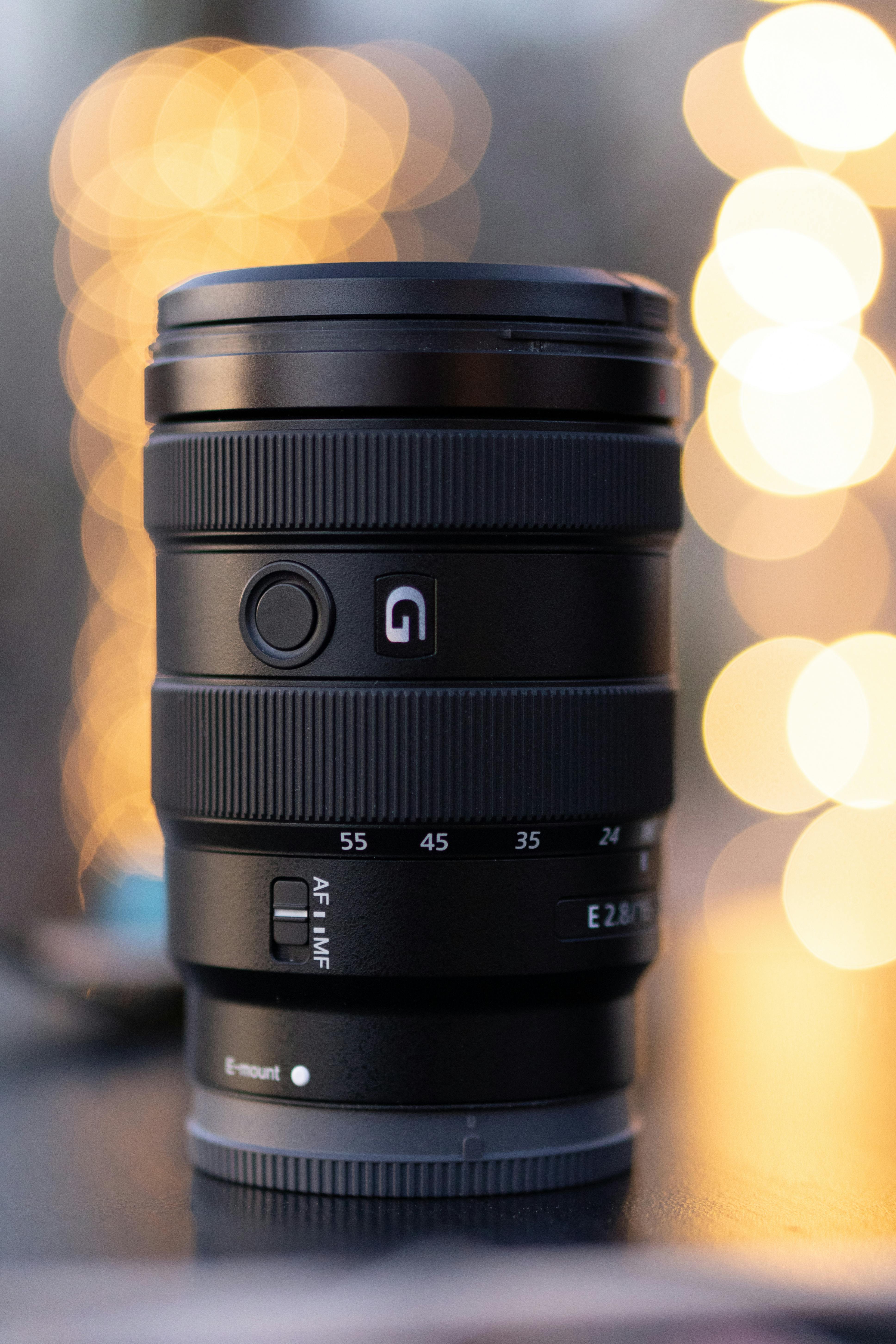 Person Holding Black Camera Lens · Free Stock Photo