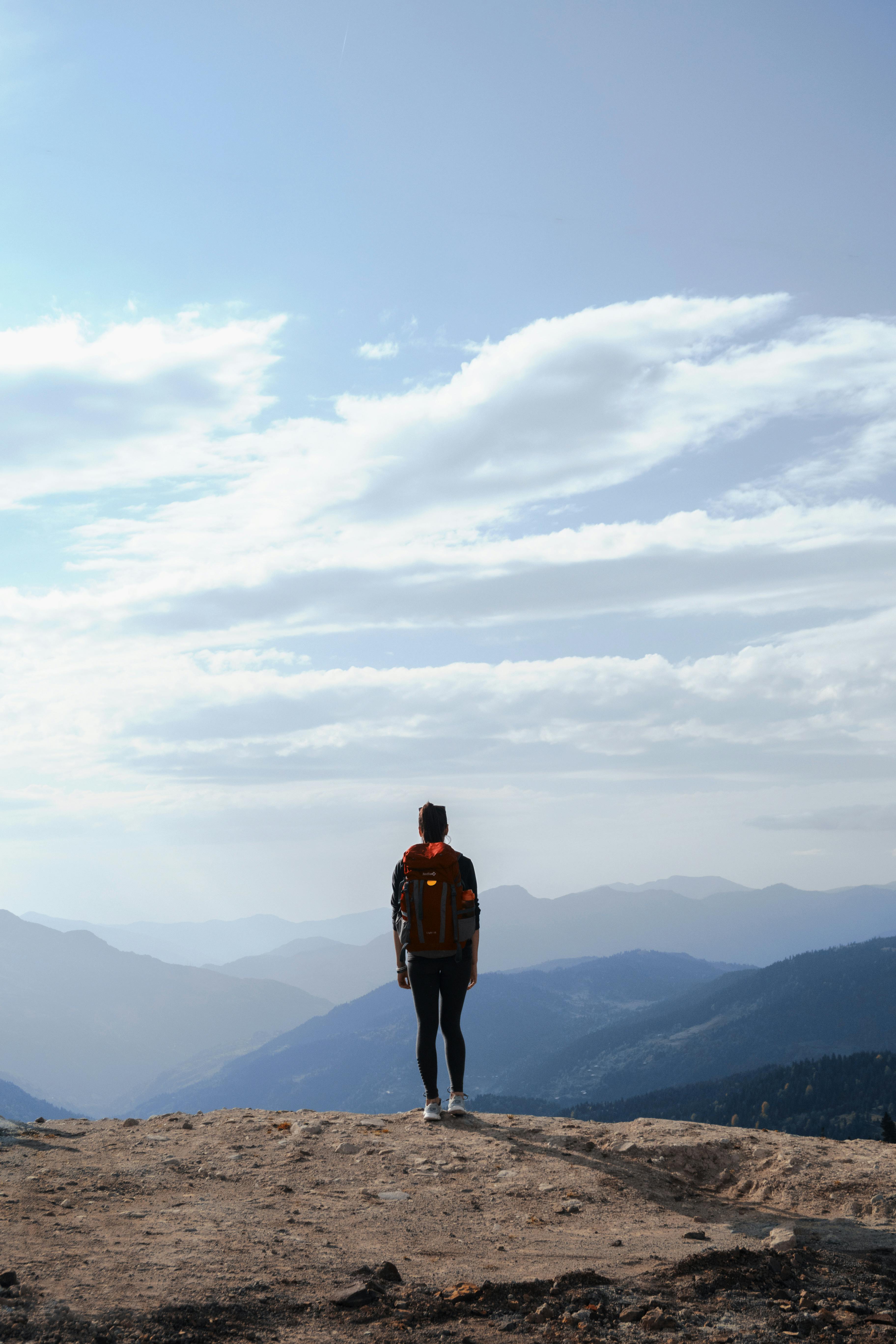 Back View of a Woman Hiking in a Mountain Landscape at Sunset · Free ...
