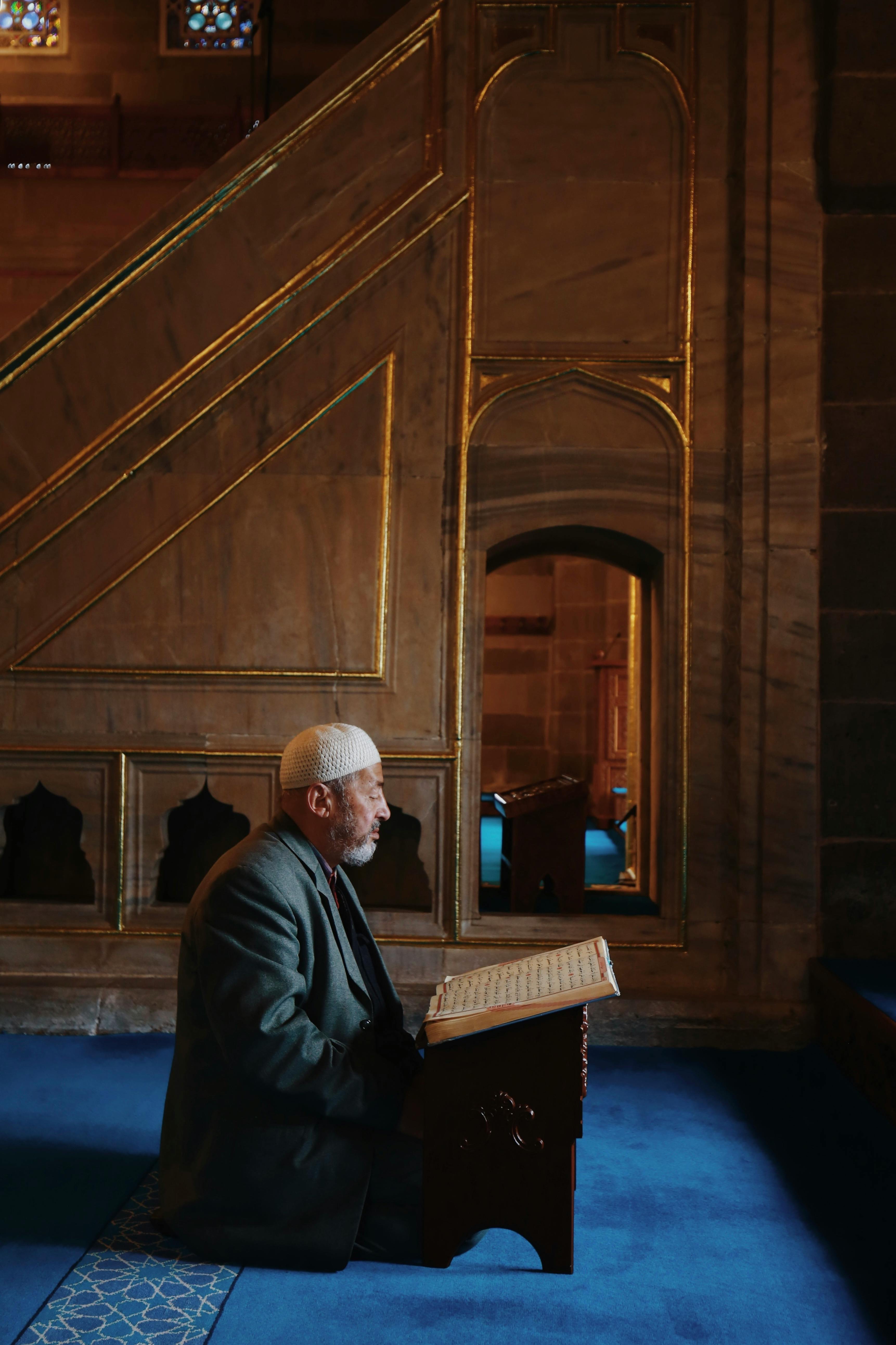 Man Reading the Koran in a Mosque · Free Stock Photo