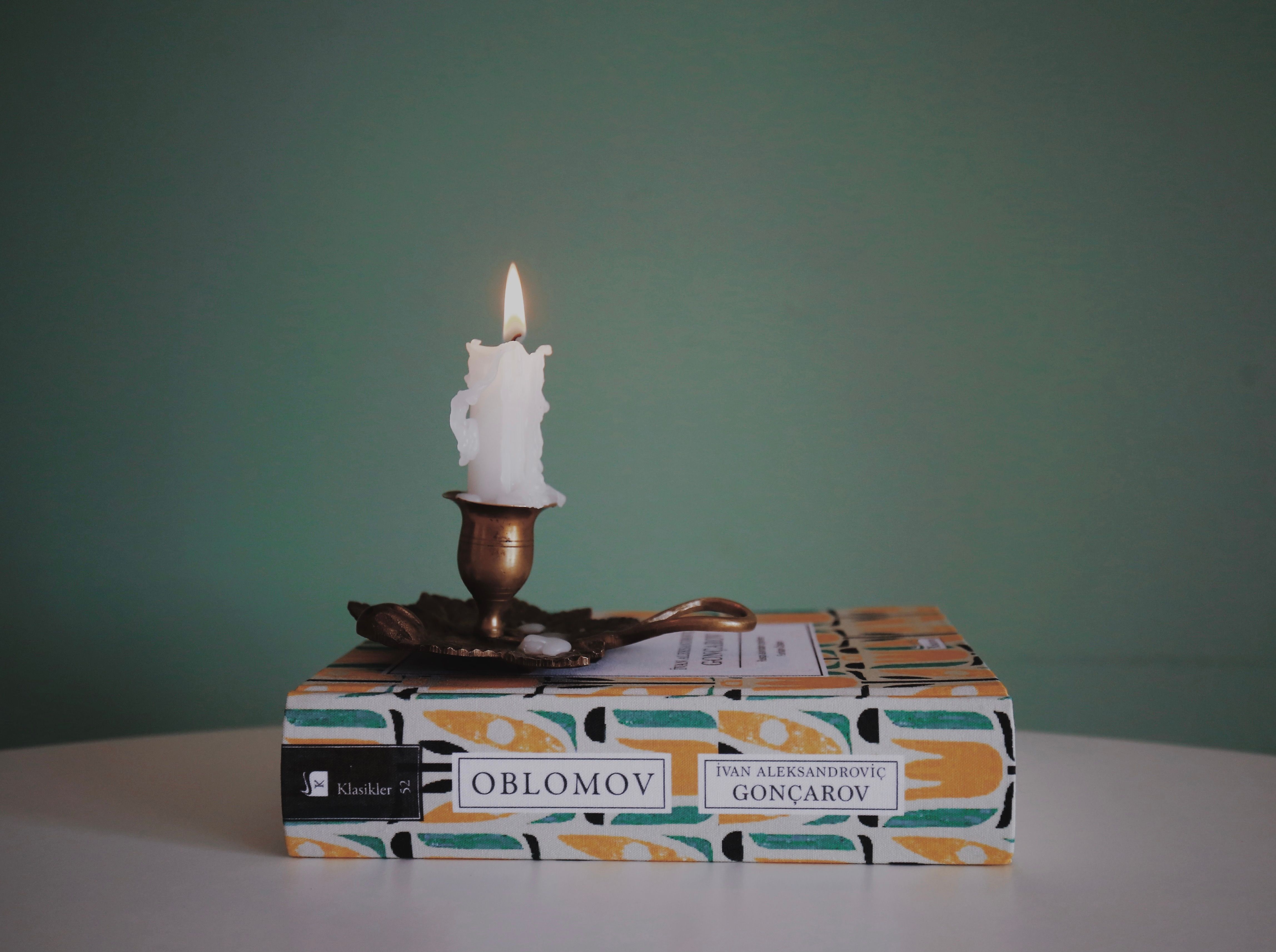 Wax Candle on Book · Free Stock Photo